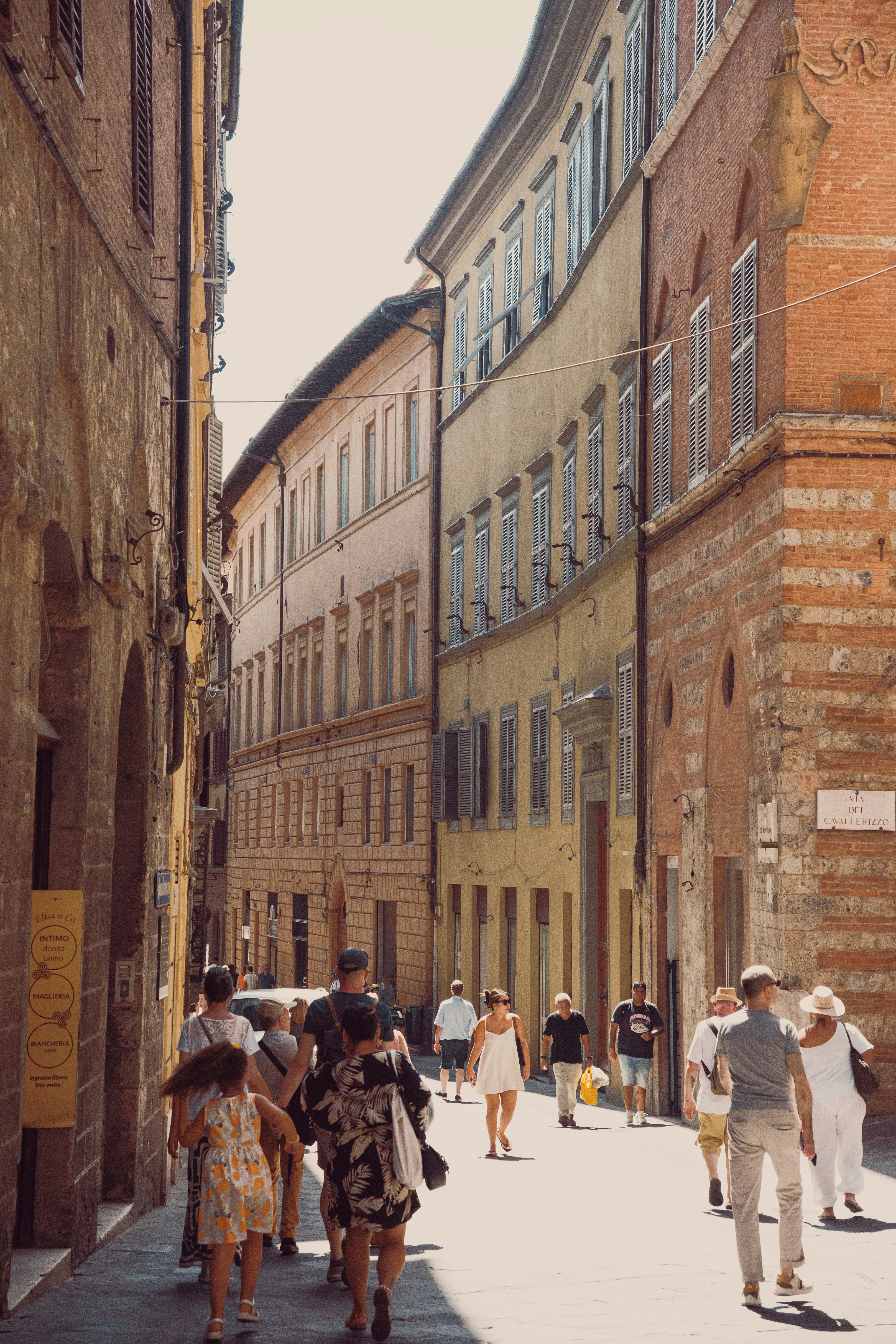 Sunlit Calle: A Quiet Corridor of Shadows and Shutters