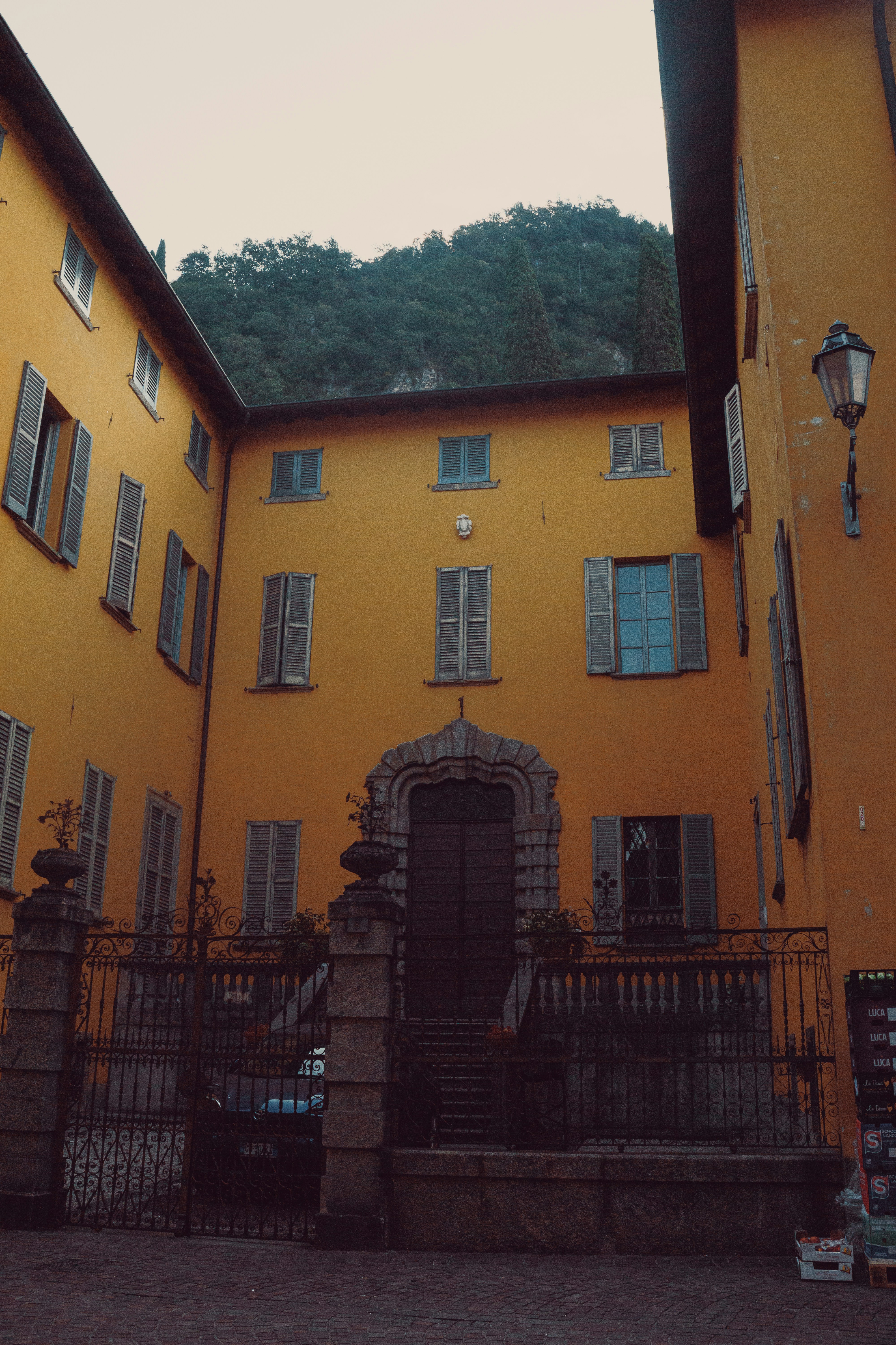 Sunlit Yellow Courtyard Courtyard Gate under Alpine Roofline
