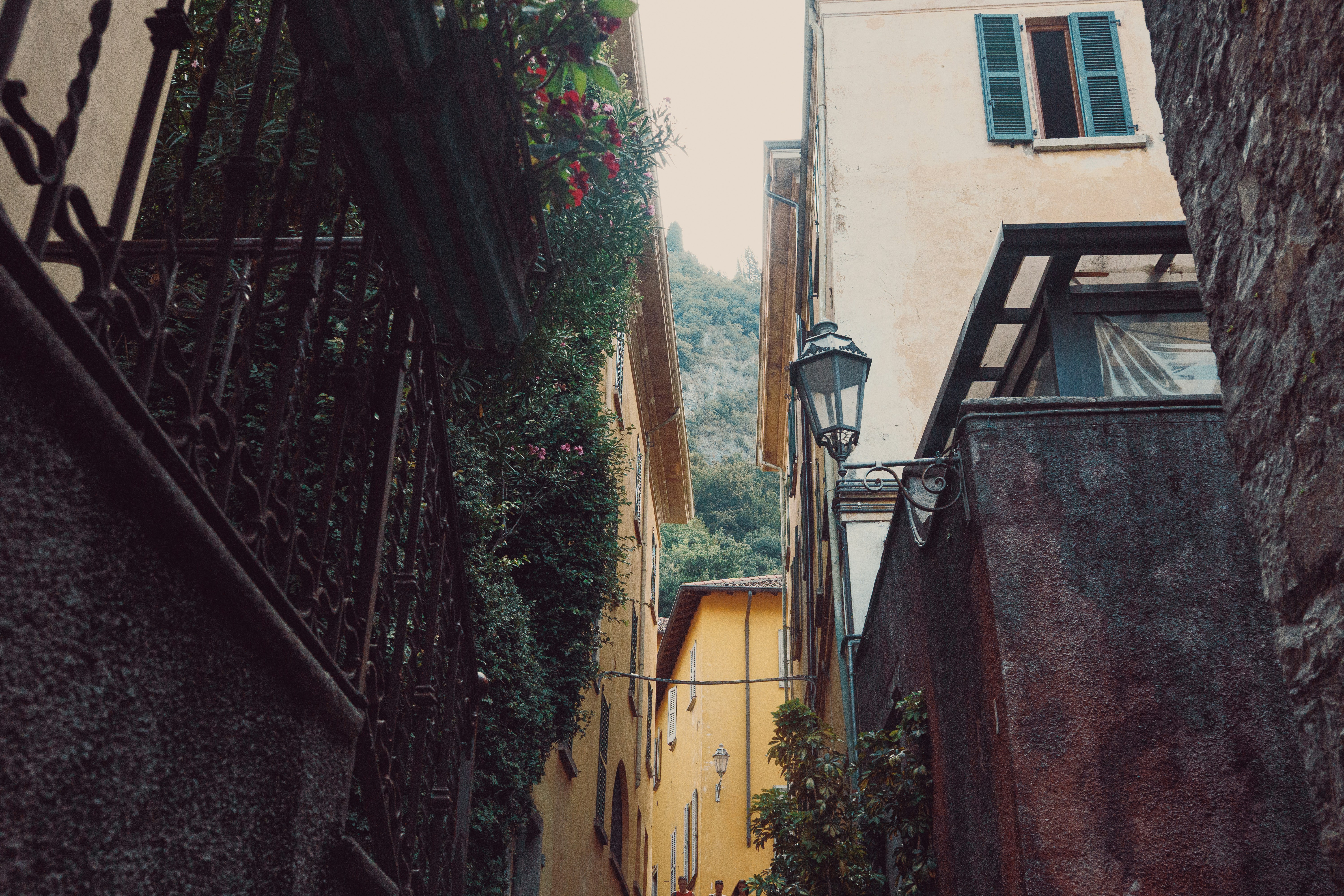 Sunlit Alleyway Between Warm Stucco and Shadowed Facades