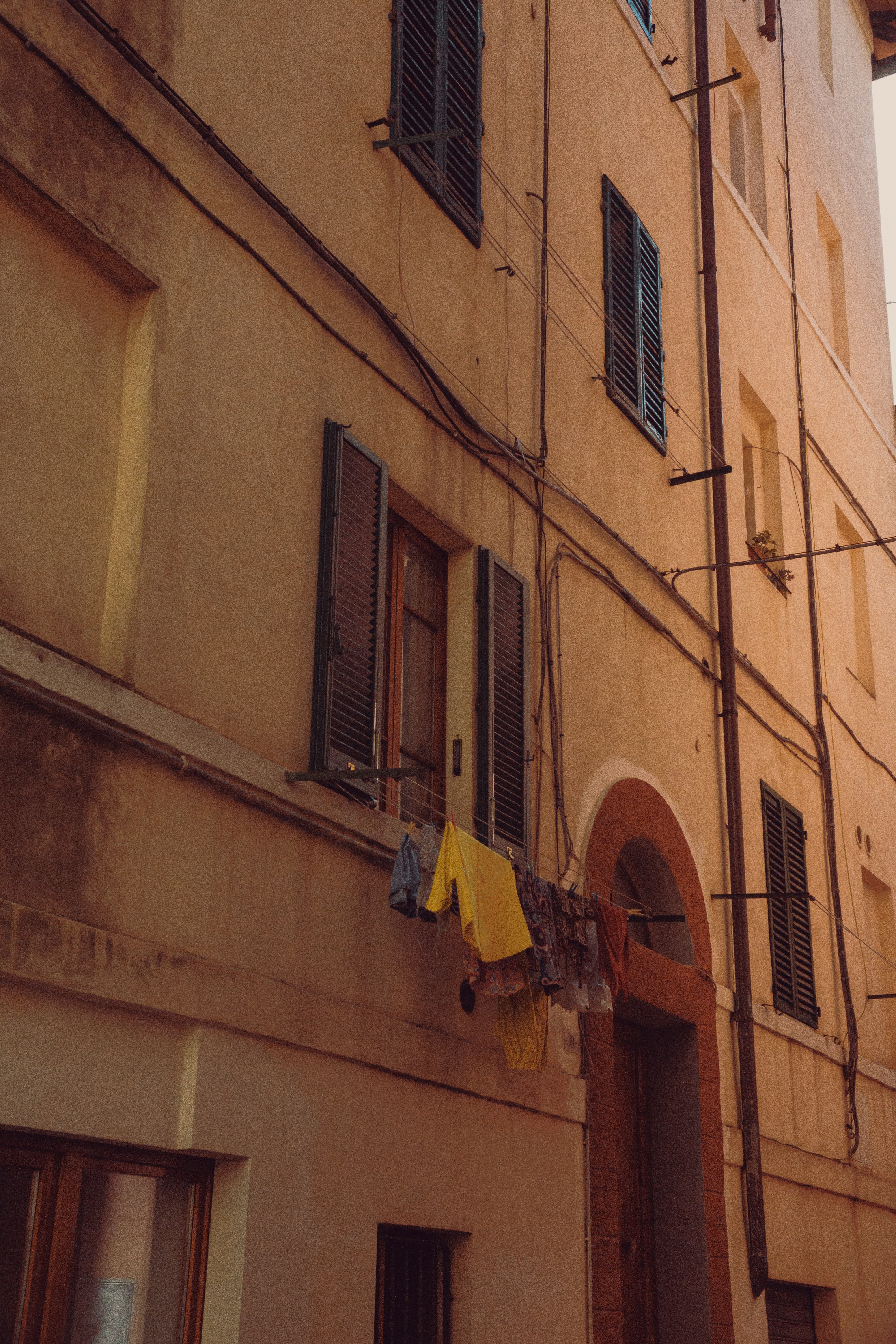 Sunlit Laundry on a Narrow European Facade