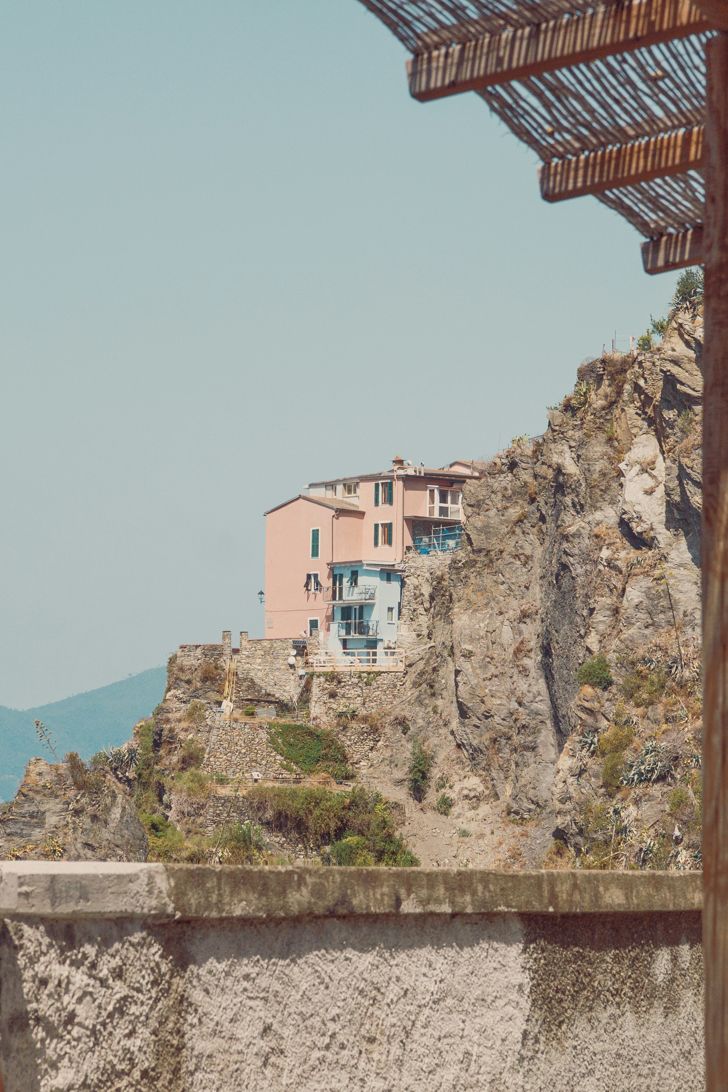 Painted cliffside home overlooking the sea