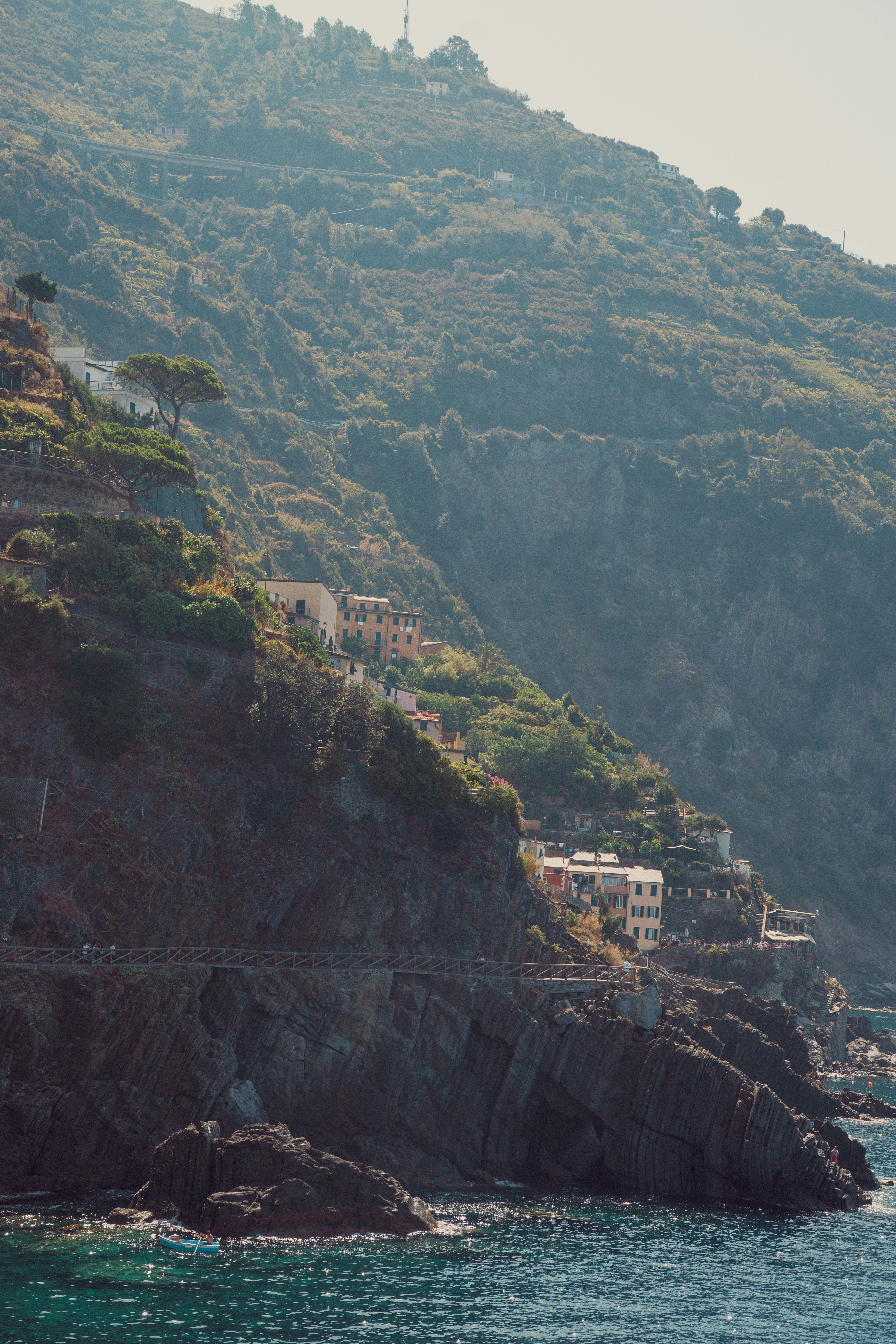 Coastal hillside village clinging to cliffs above turquoise seas