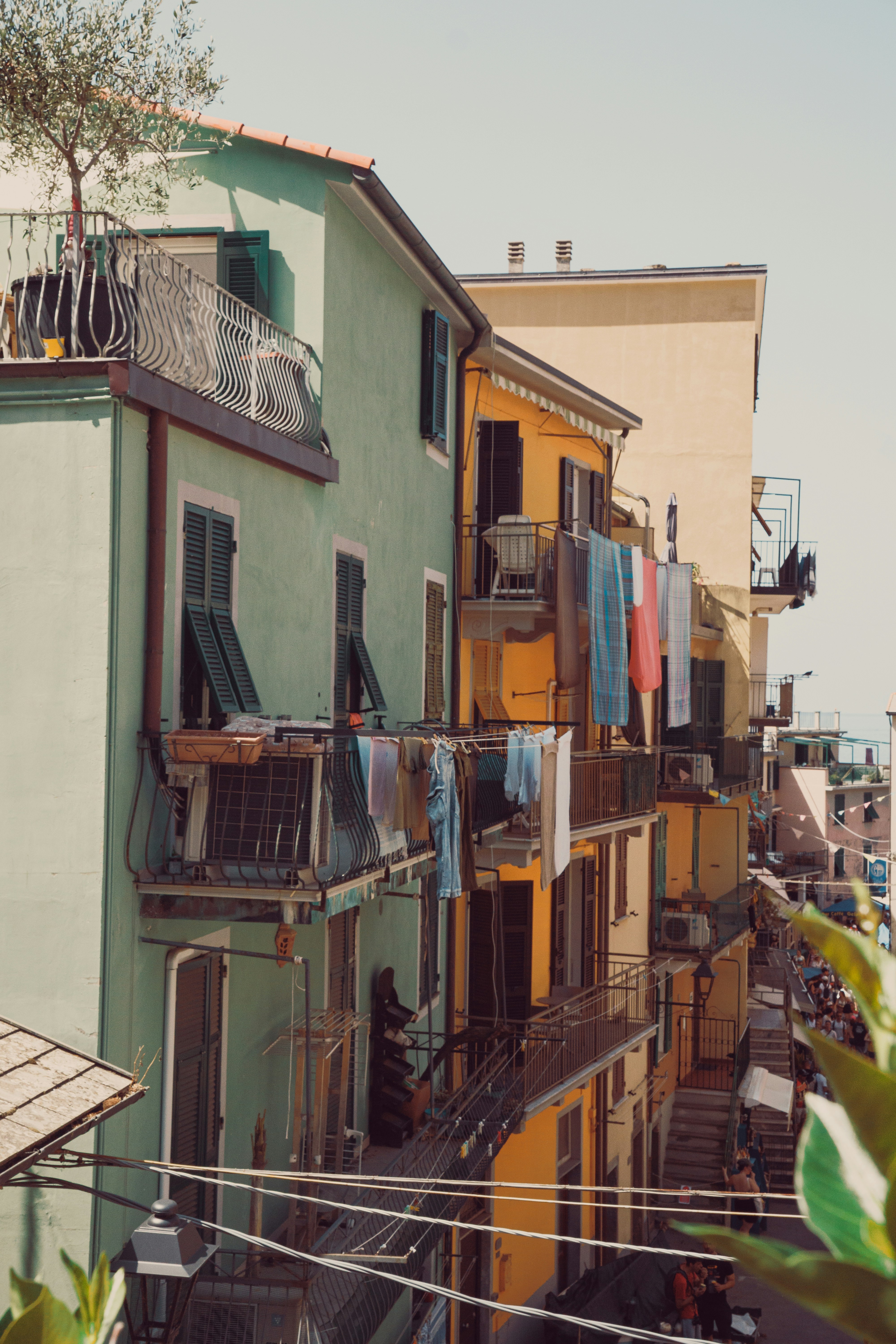 Sunlit Coastline Courtyard: Colorful Balconies Lean into the Street