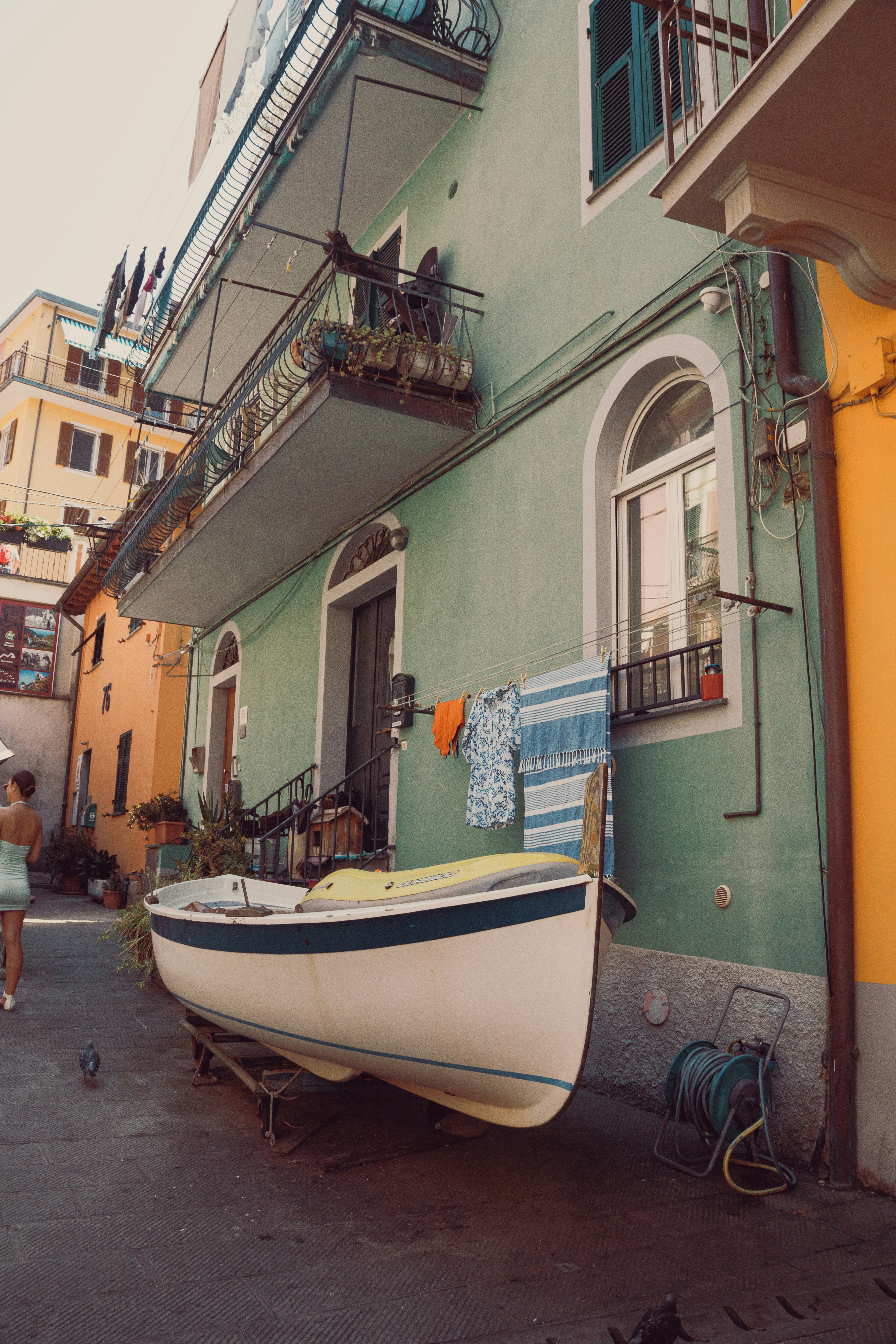 Vivid Coastal Lane with a Boat Belonging to a Sunlit Balcony