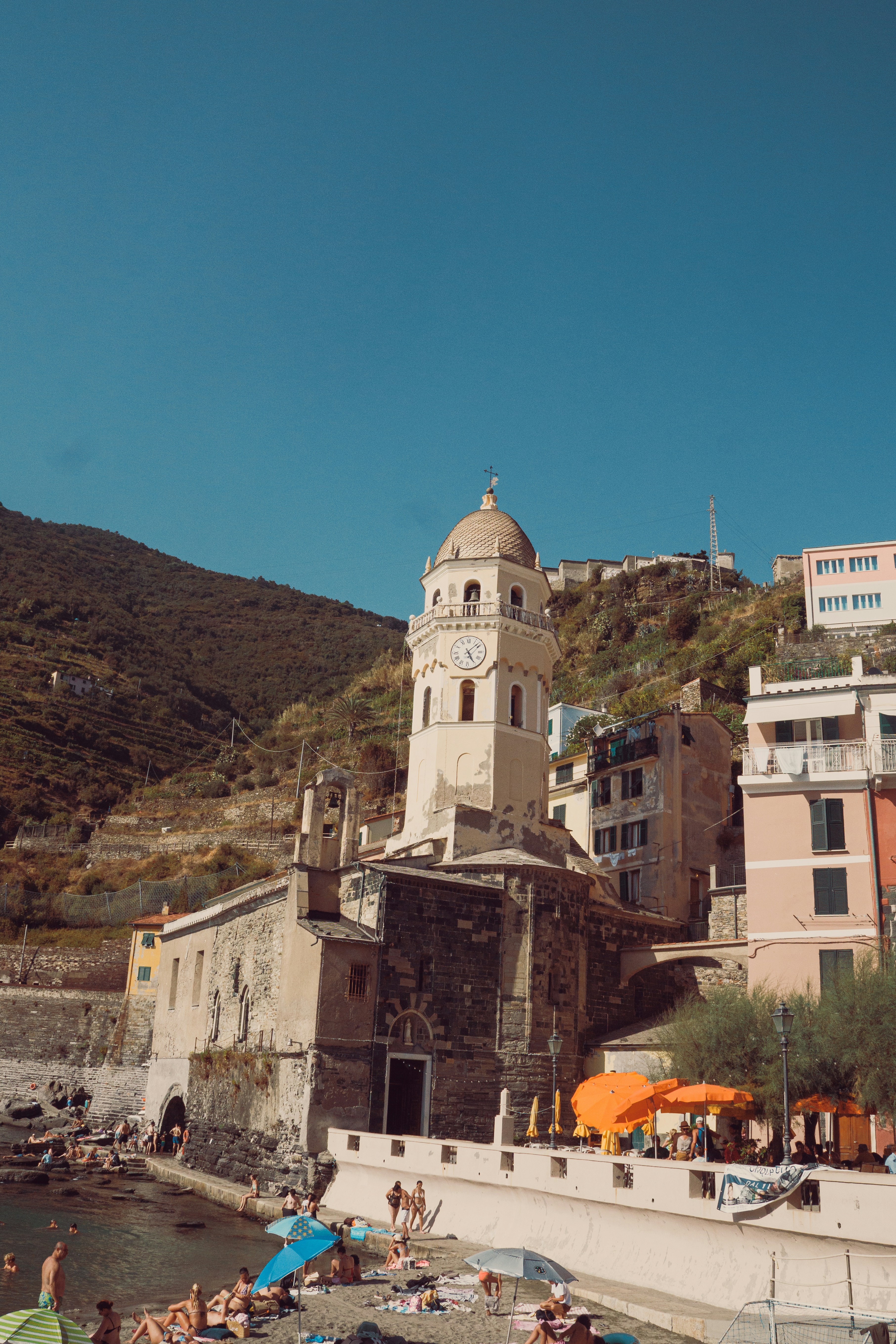 Timeworn Clock Tower Overlooking a Sunny Harbor