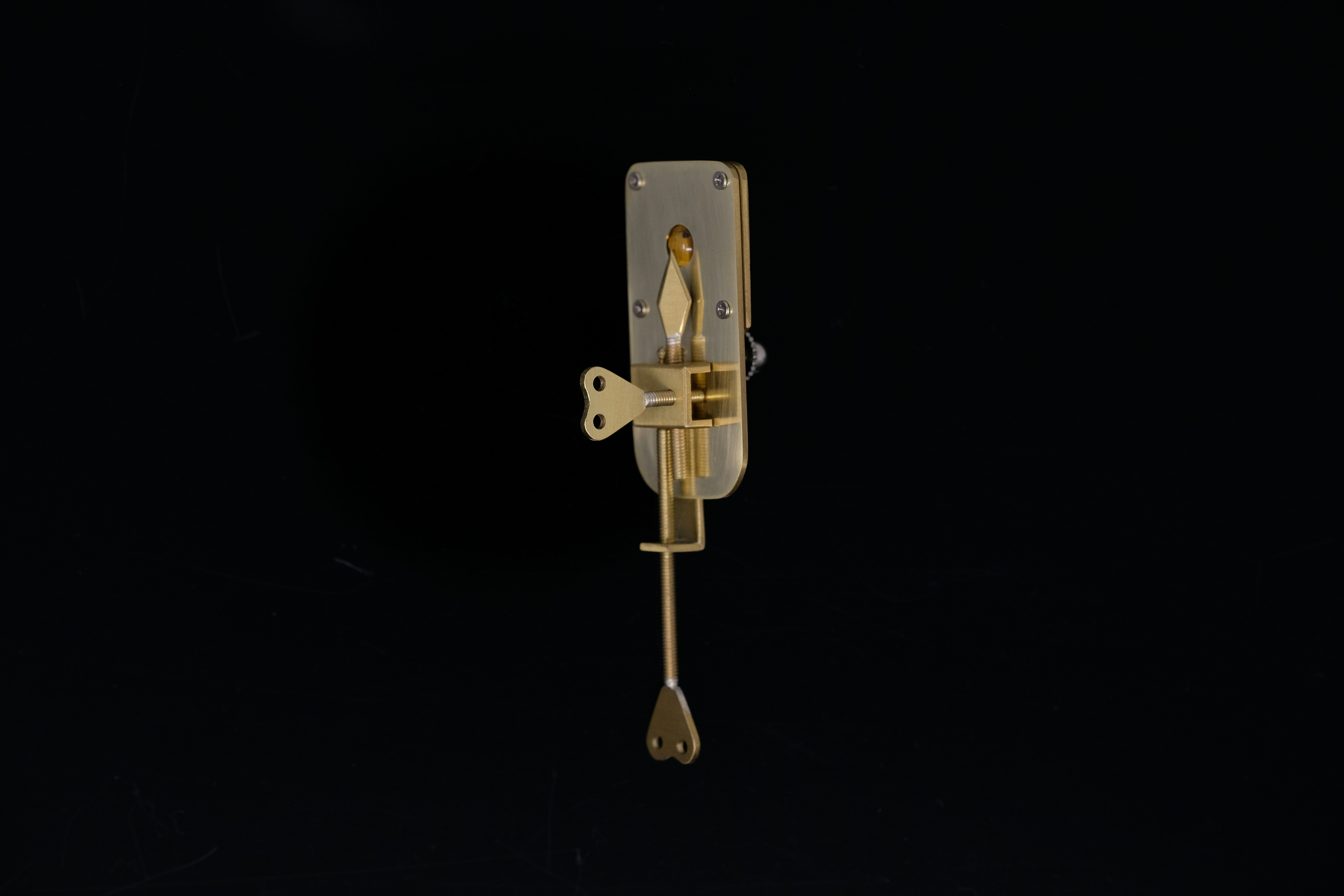 Gold-tinted Lock Mechanism Suspended in Velvet Darkness