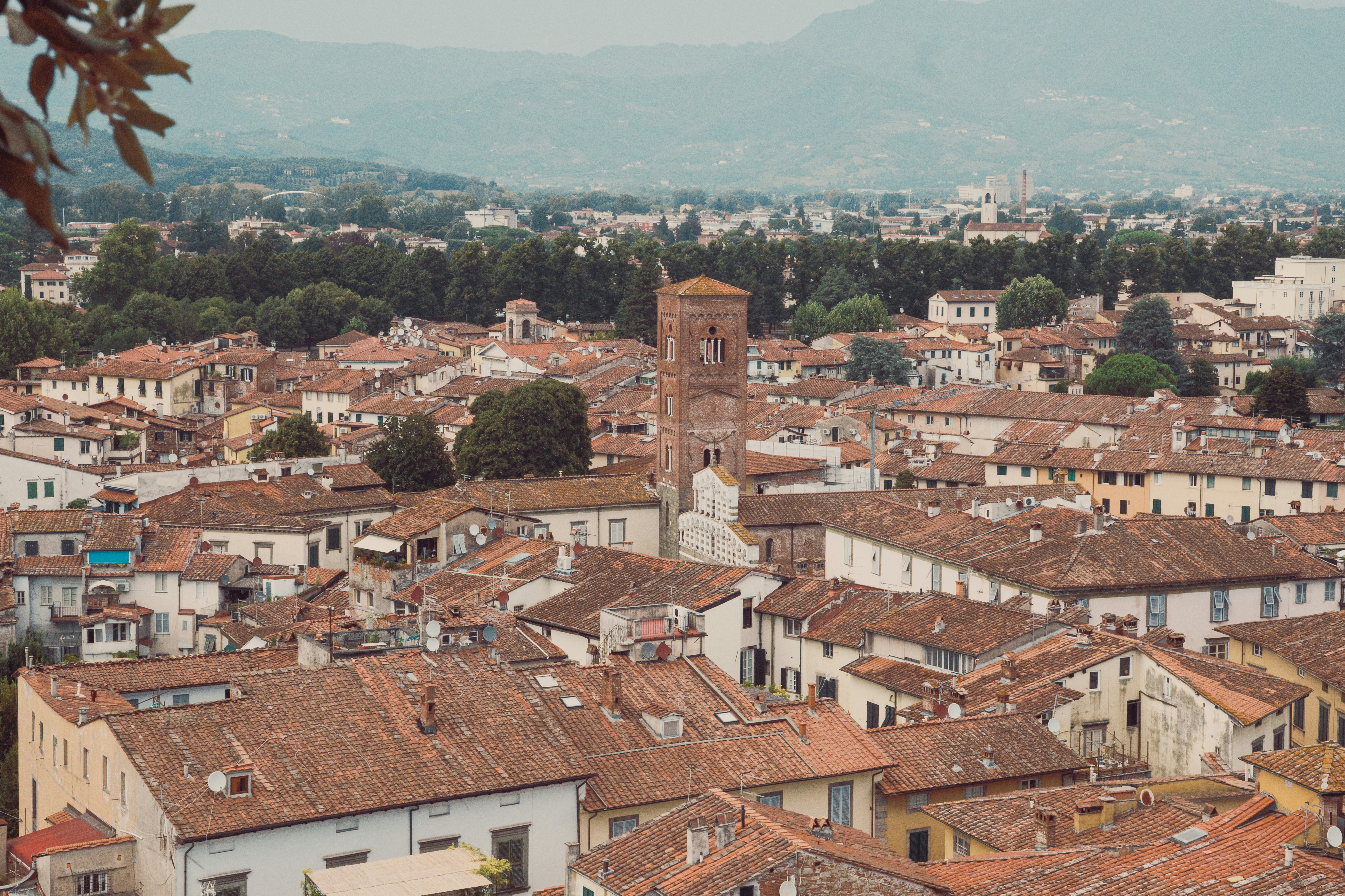 Aerial View Over a Terracotta-Tiled Italian Town with a Prominent Bell Tower