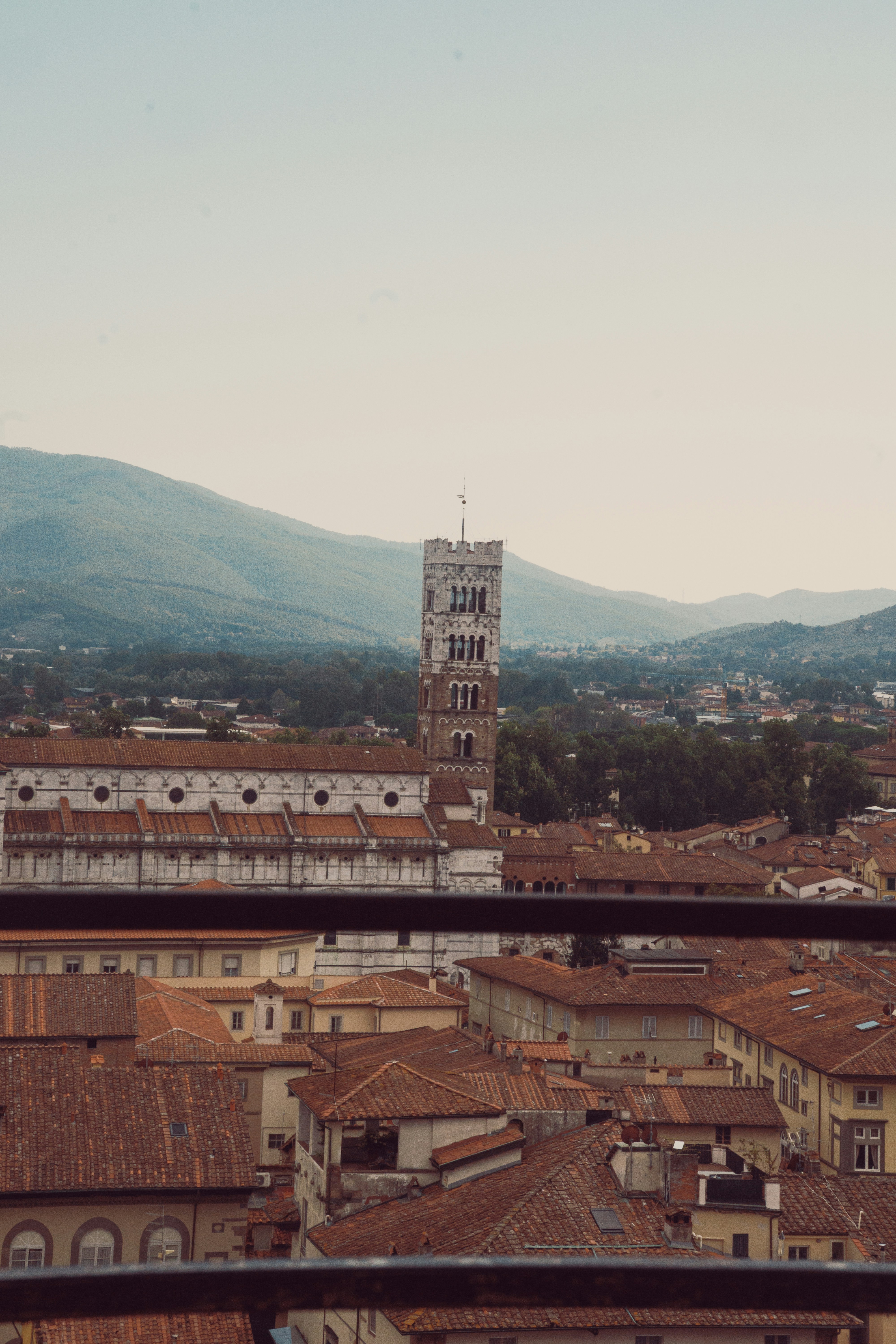 Red-Tiled Rooftops Beneath a Towered Watch