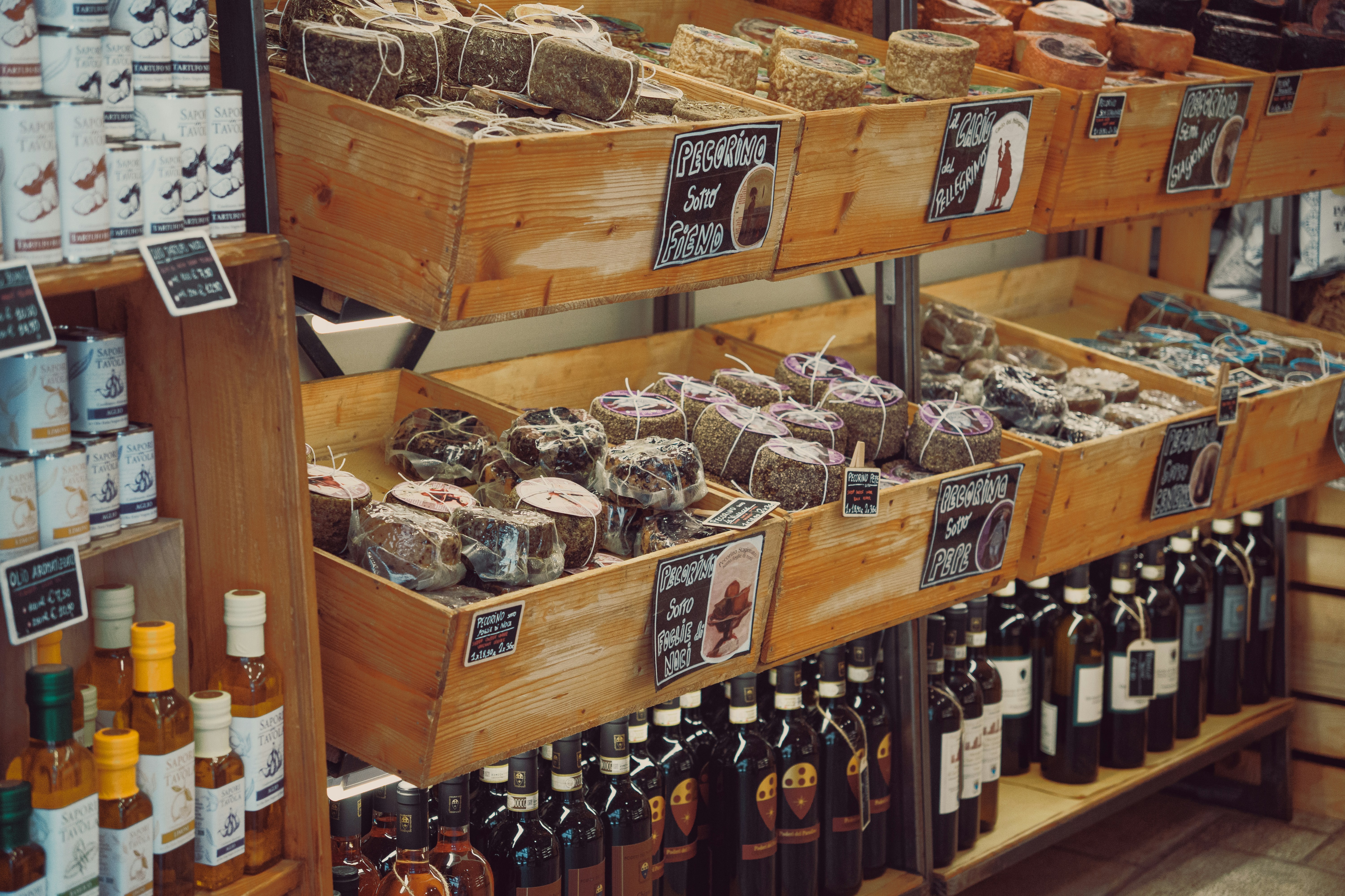 Aged Cheeses in Wooden Shelves: A Rustic Market Display