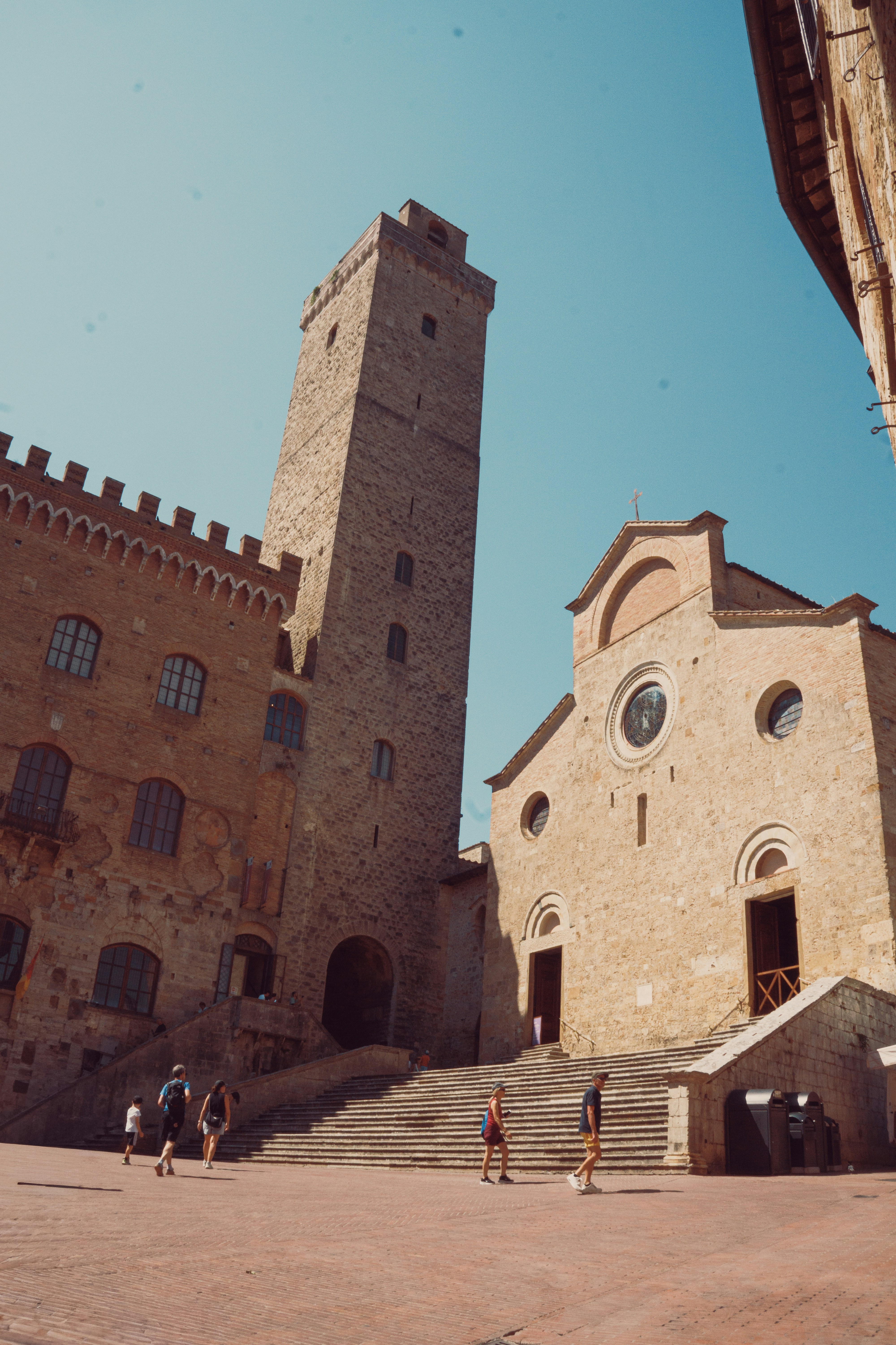 Stone Tower and Staircase: A Sunlit Piazza at the Gate of an Ancient Fortress
