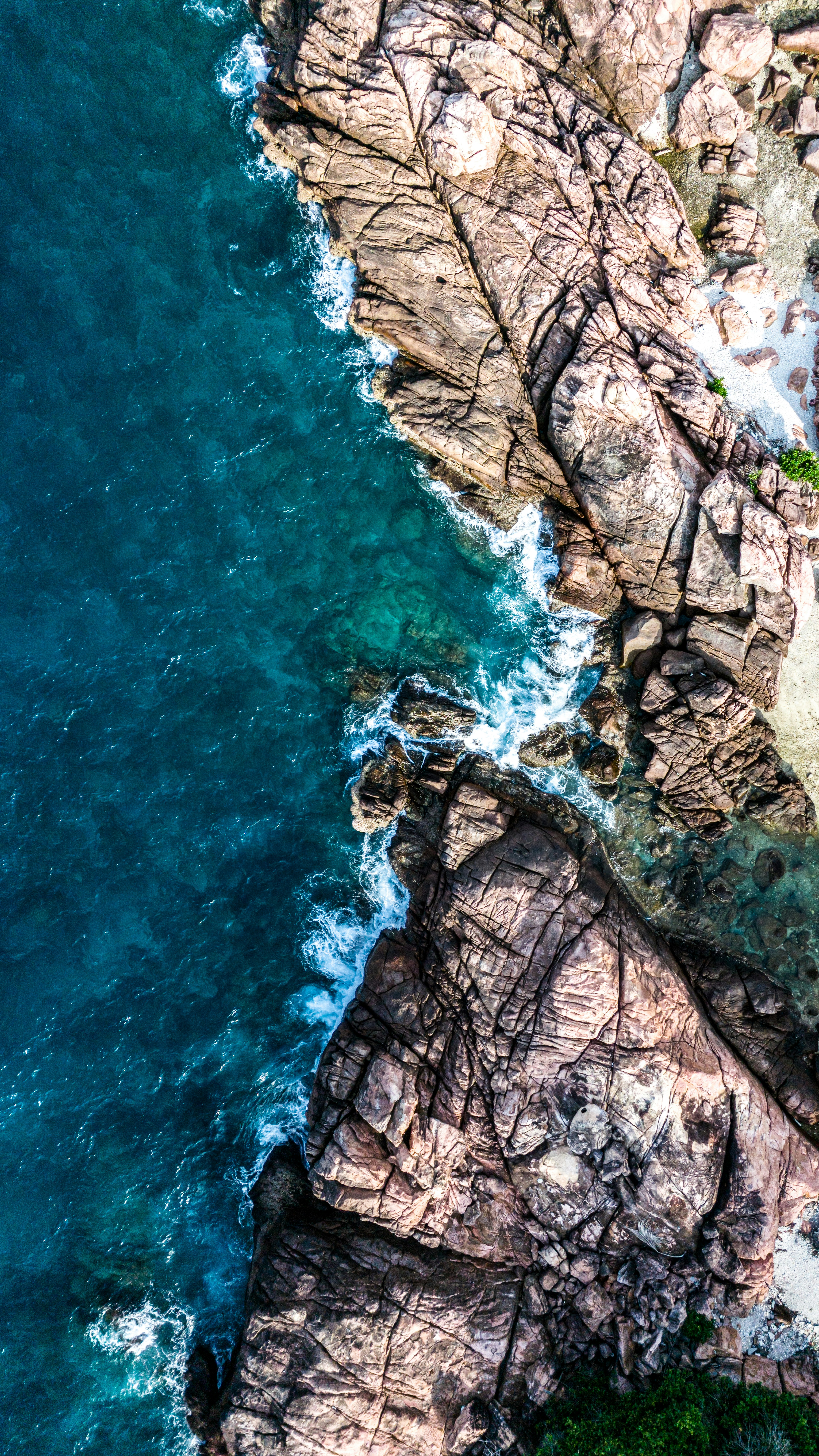 Coastal Cliffs Carved by Tide: Aerial Portrait of Rugged Shoreline