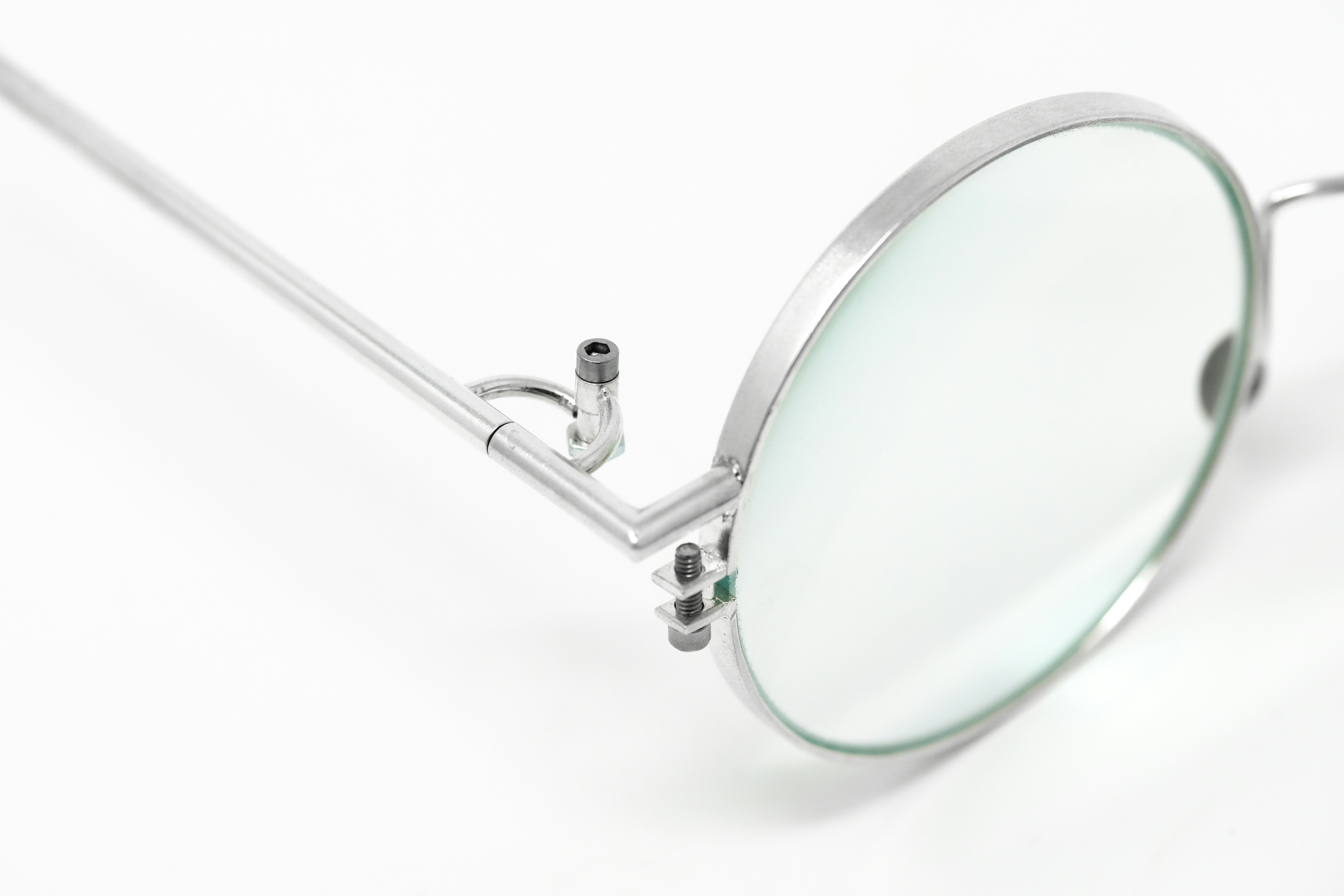 A Quiet Glimpse: Round Lens and Glassy Steel