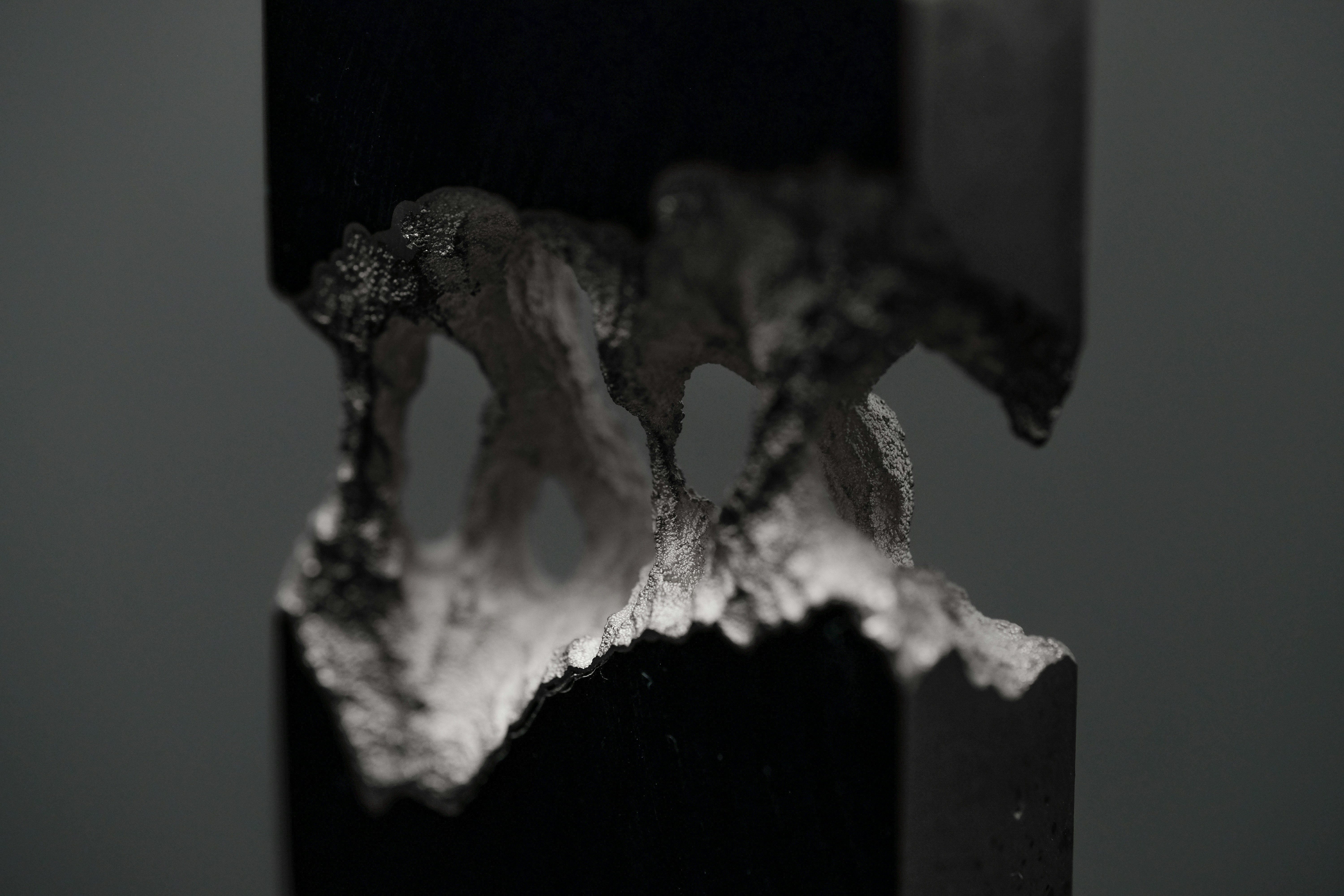 Charred remains of a metal support: a study in ash and shadow