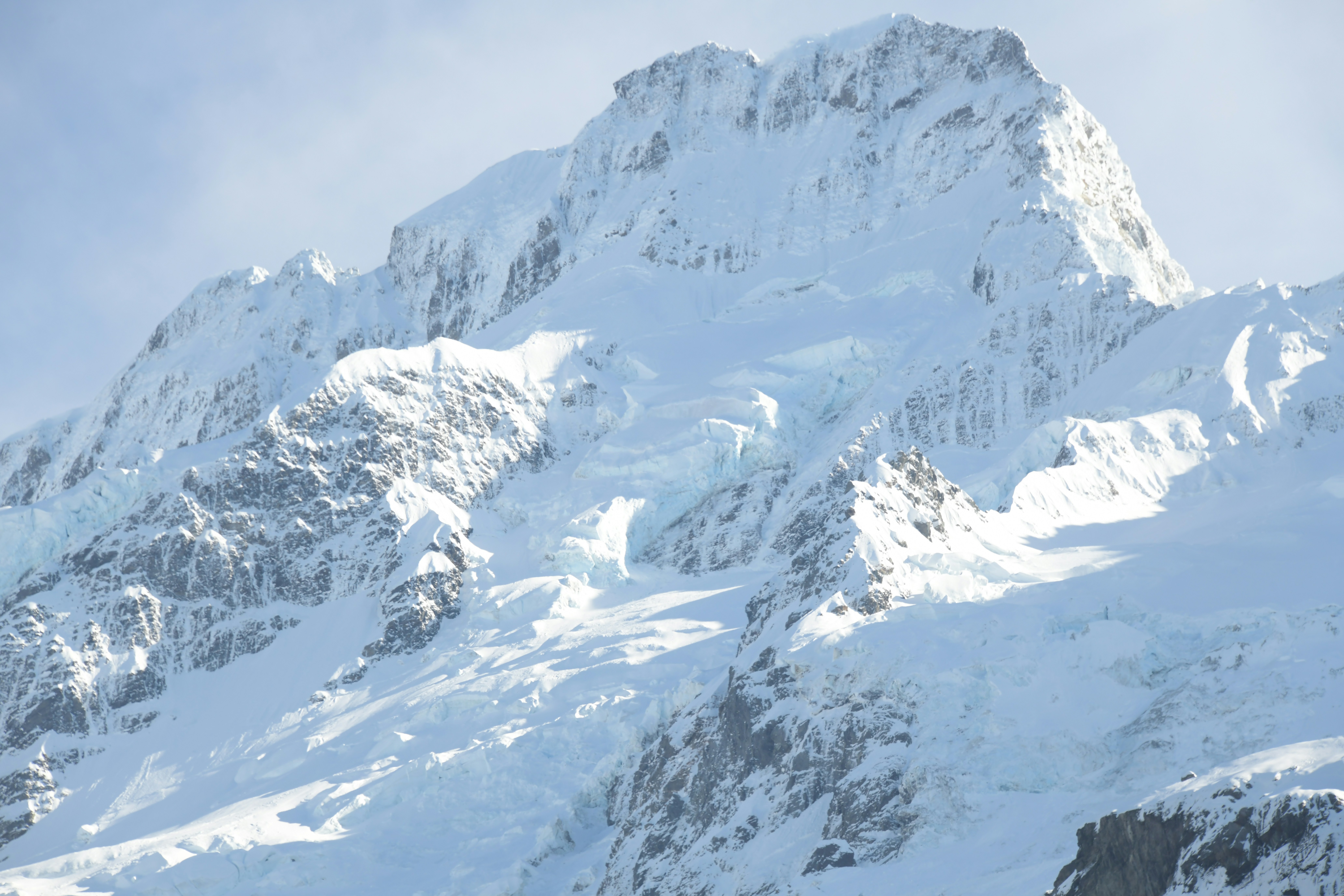 Snowbound Cathedral: A Close-Up of Jagged Peaks Under Clear Sky