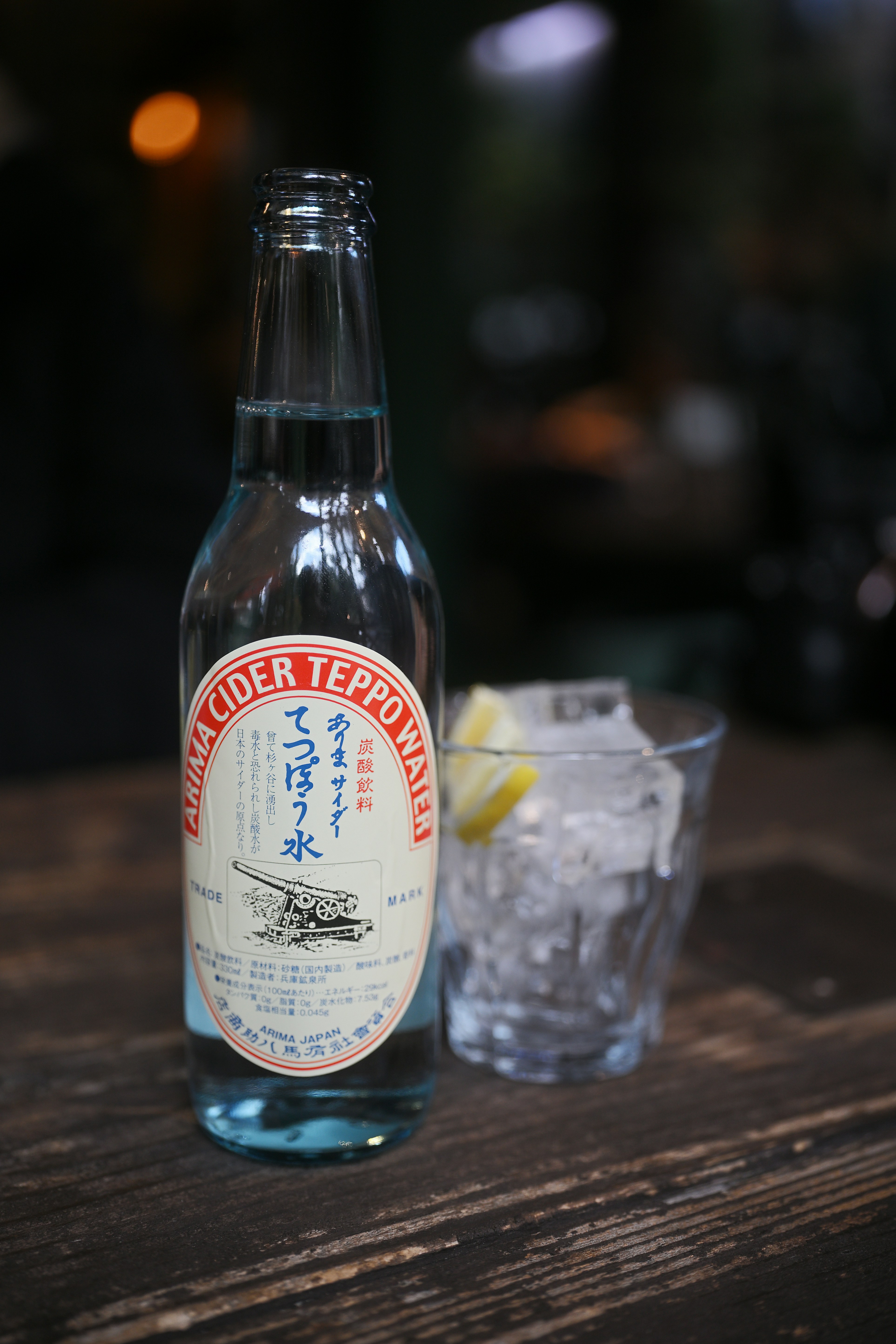 Blue Glass, Soft Light: A Bottled Moment at the Bar