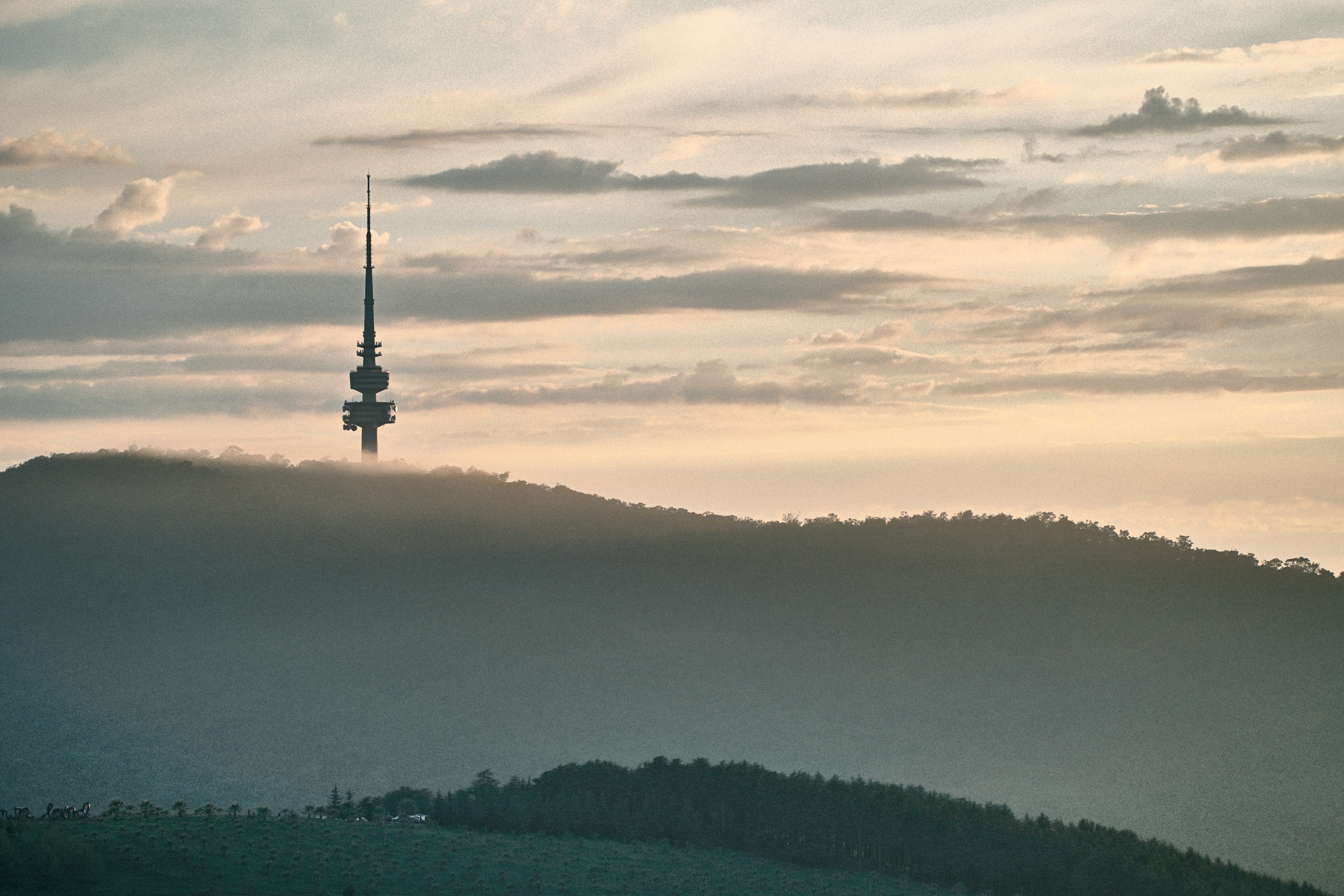 Silhouette of a Radio Mast Rimming the Horizon at Dawn