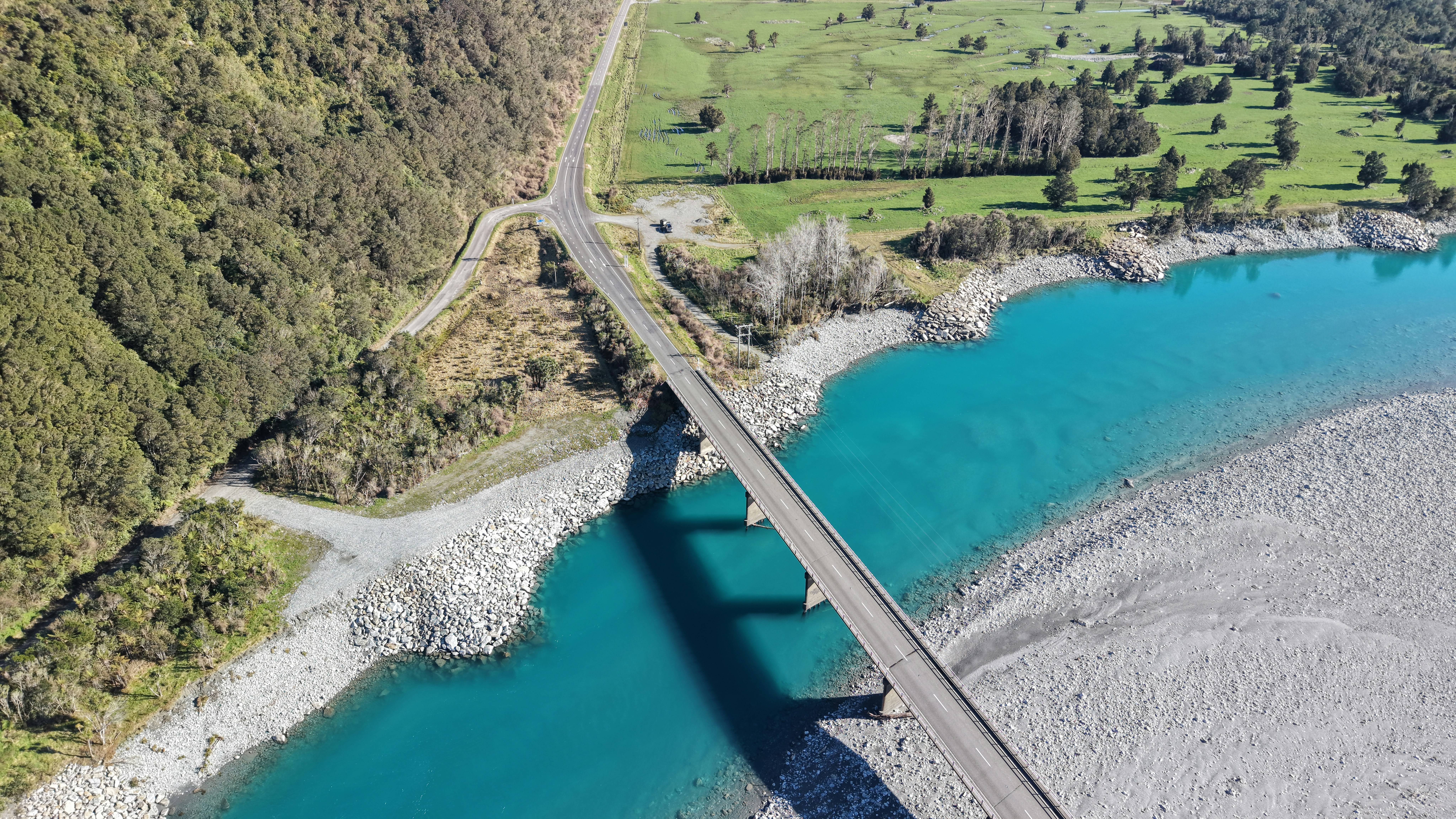 A Streamlined Arc: A Turquoise River Binds a Narrow Bridge