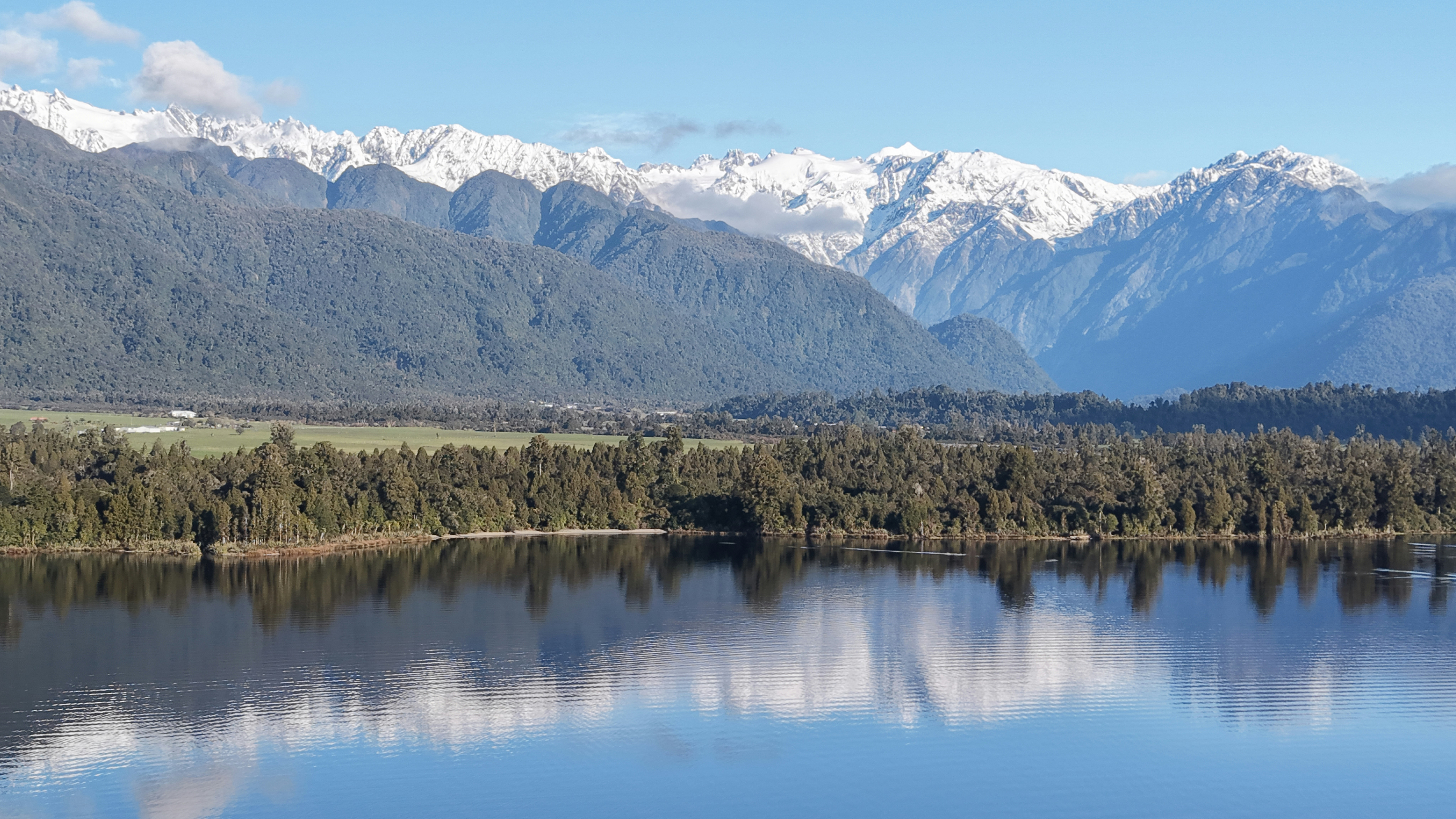 Mirror of Mountains: Snowcaps and Still Waters Reflecting a Quiet Valley