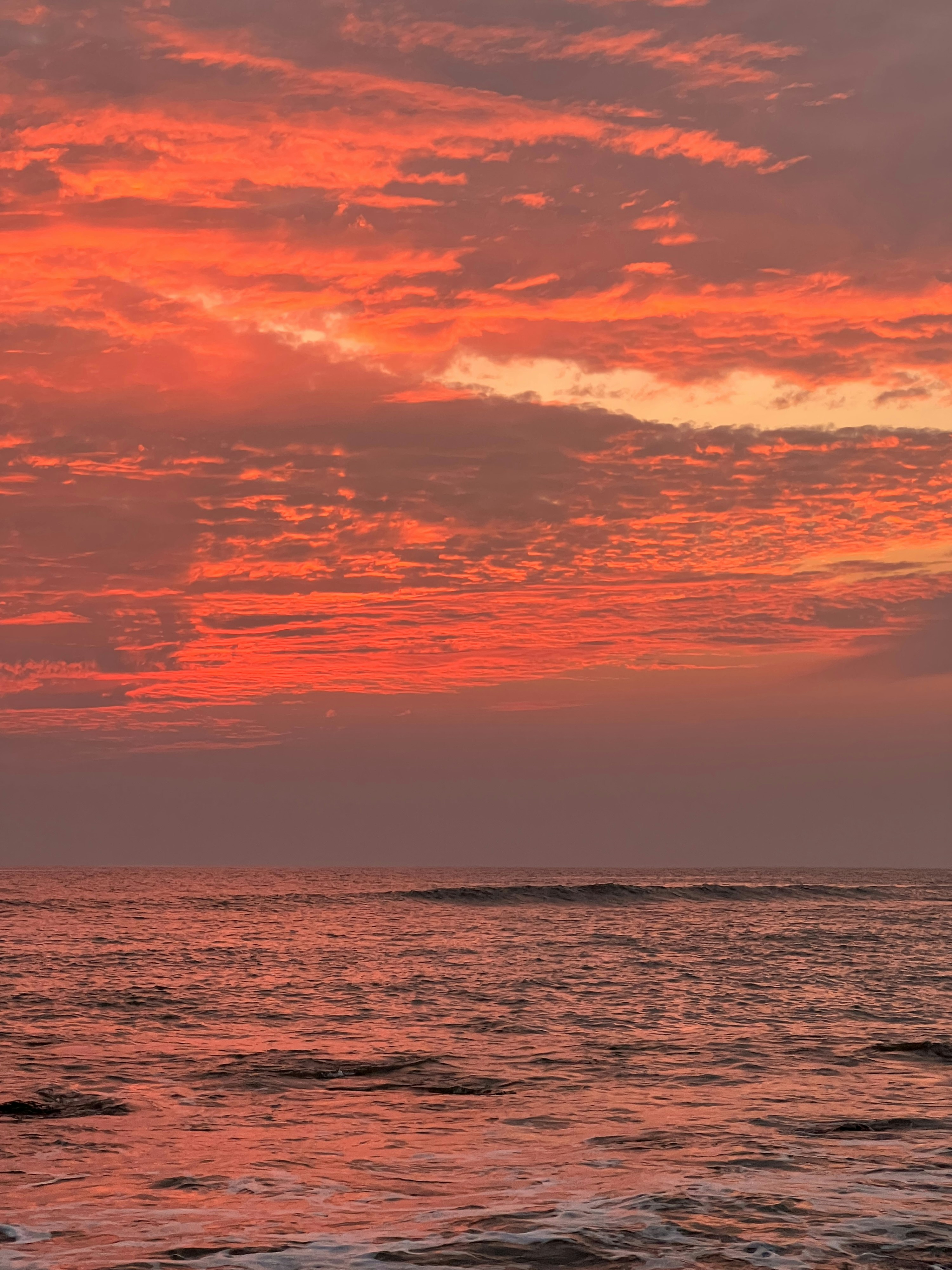 Fiery horizon at dusk over a calm sea