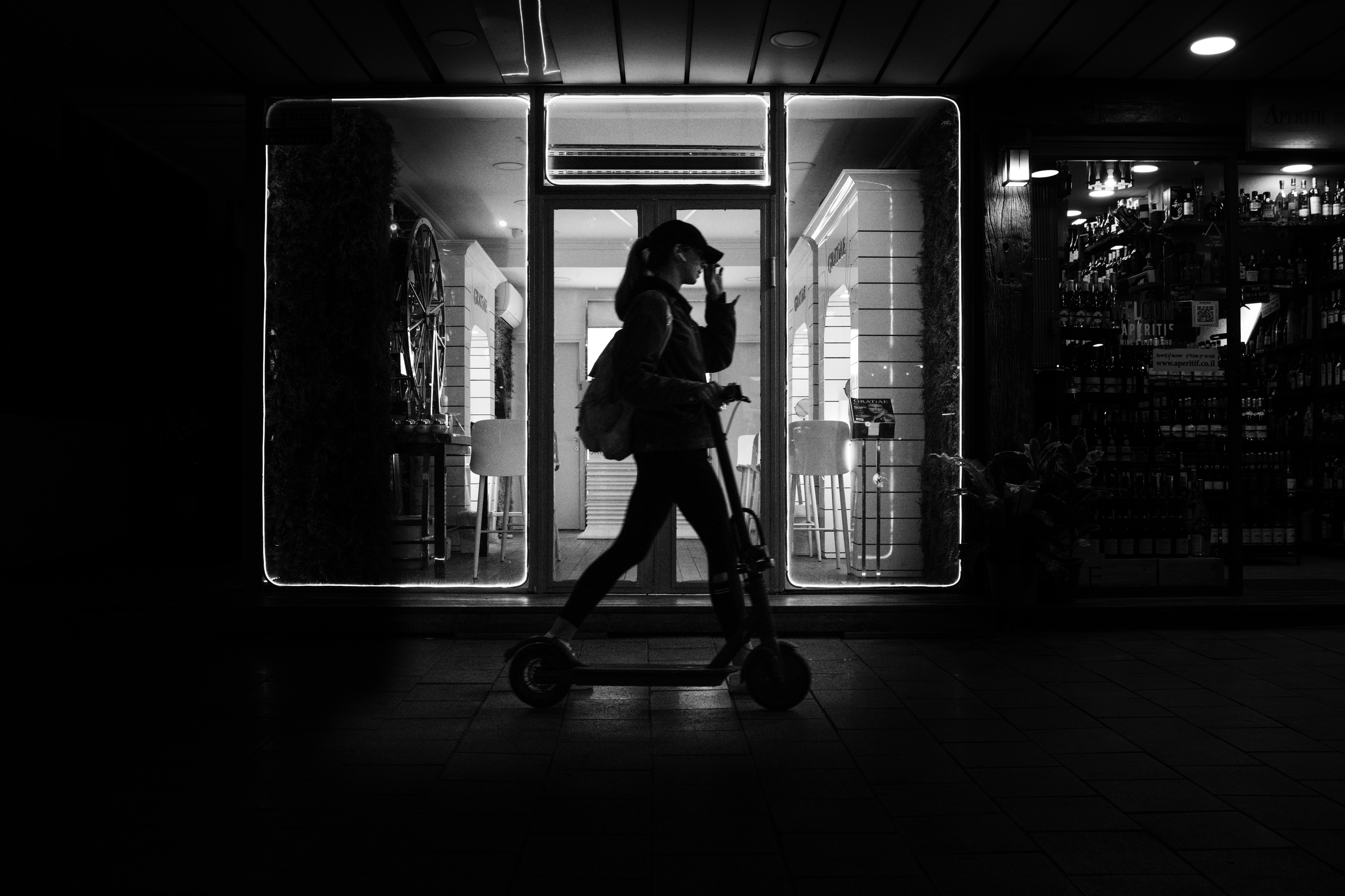 Midnight Glide: silhouette of a rider crossing a neon-lit doorway