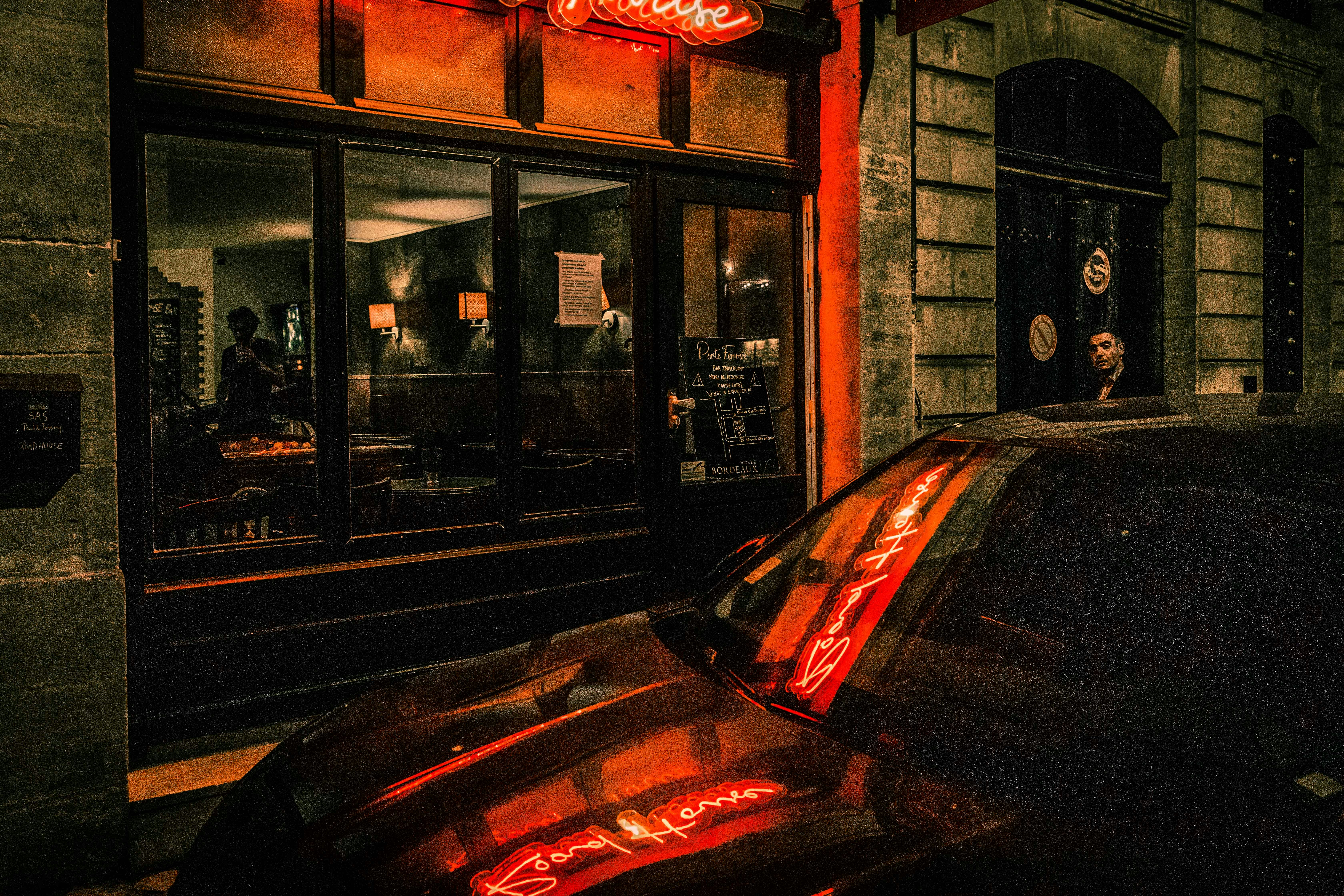 Neon Glow on a Quiet Street: Nightlife Reflected in a City Window