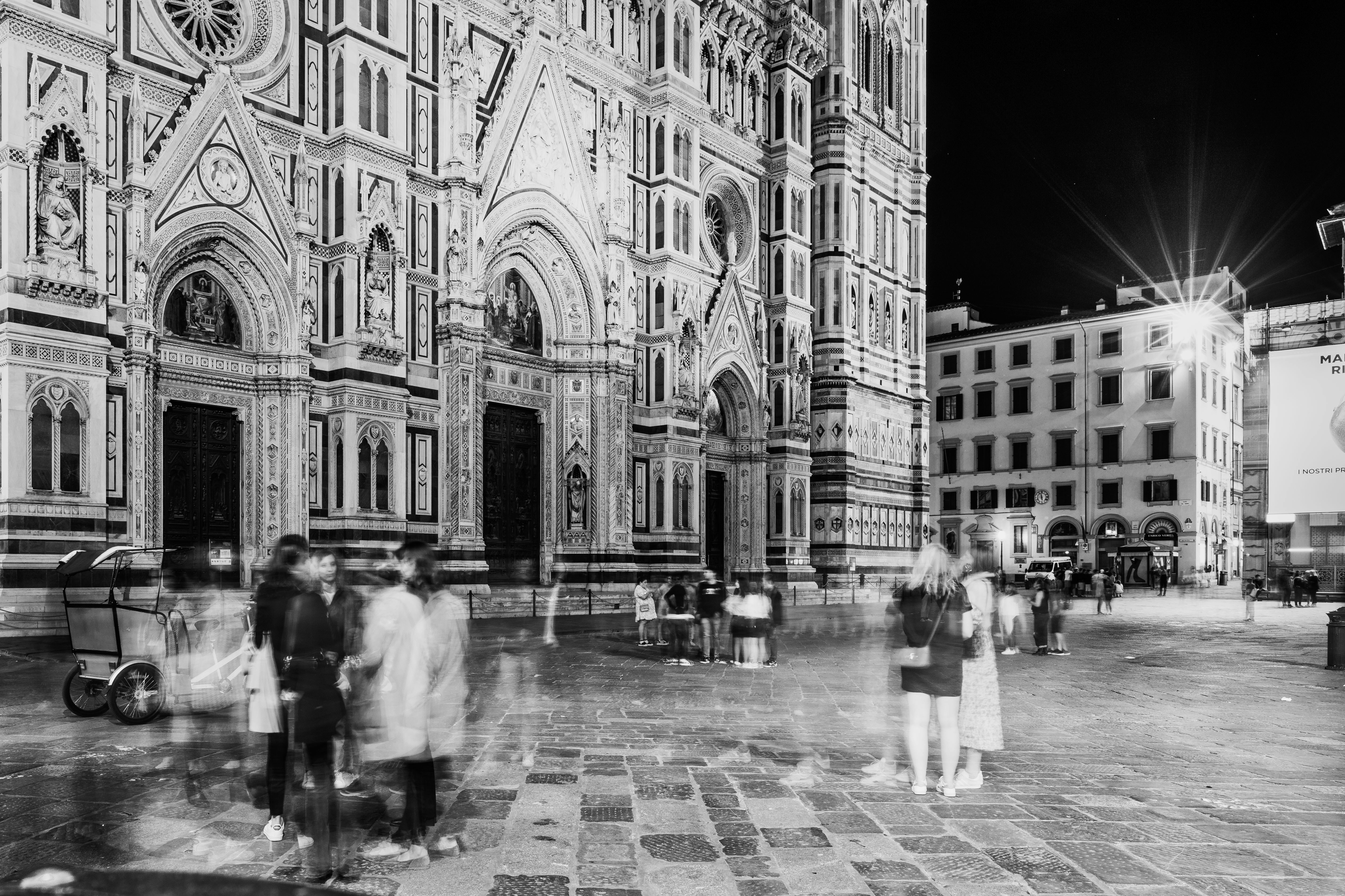 Night at the Gothic Facade: People in Motion Before the Cathedral