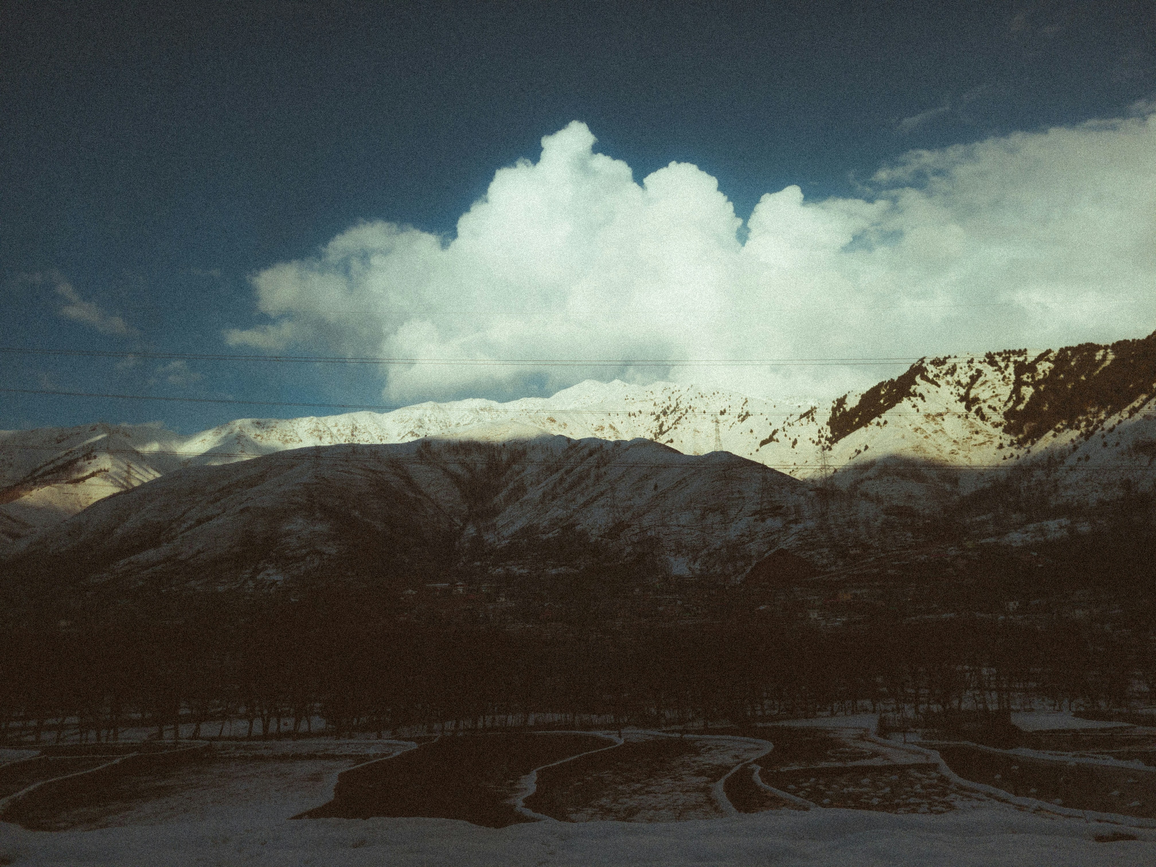 Snow-Capped Ridge Under a Quiet Sky