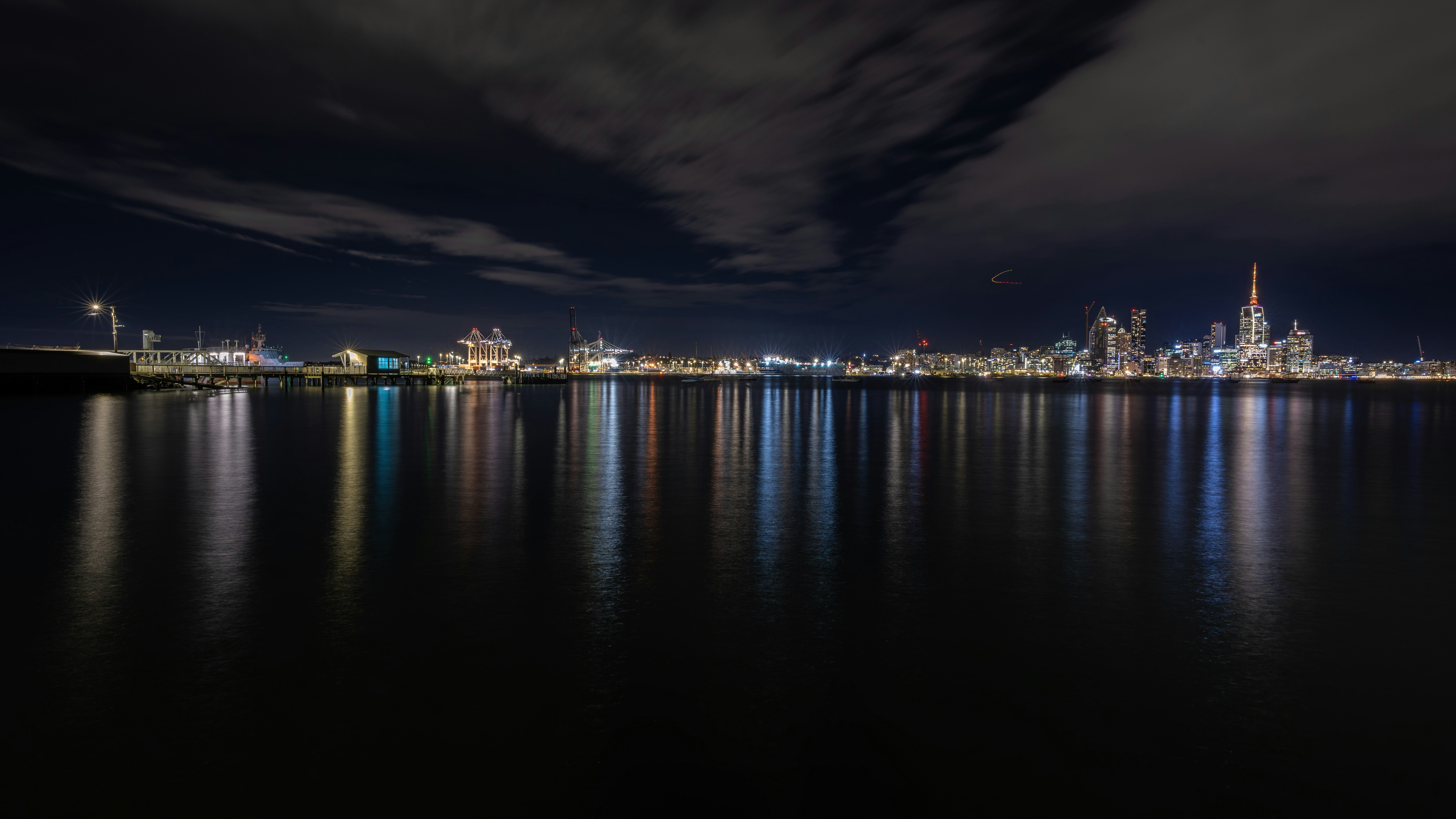 Midnight Skyline: City Lights Rippling Across the Harbor