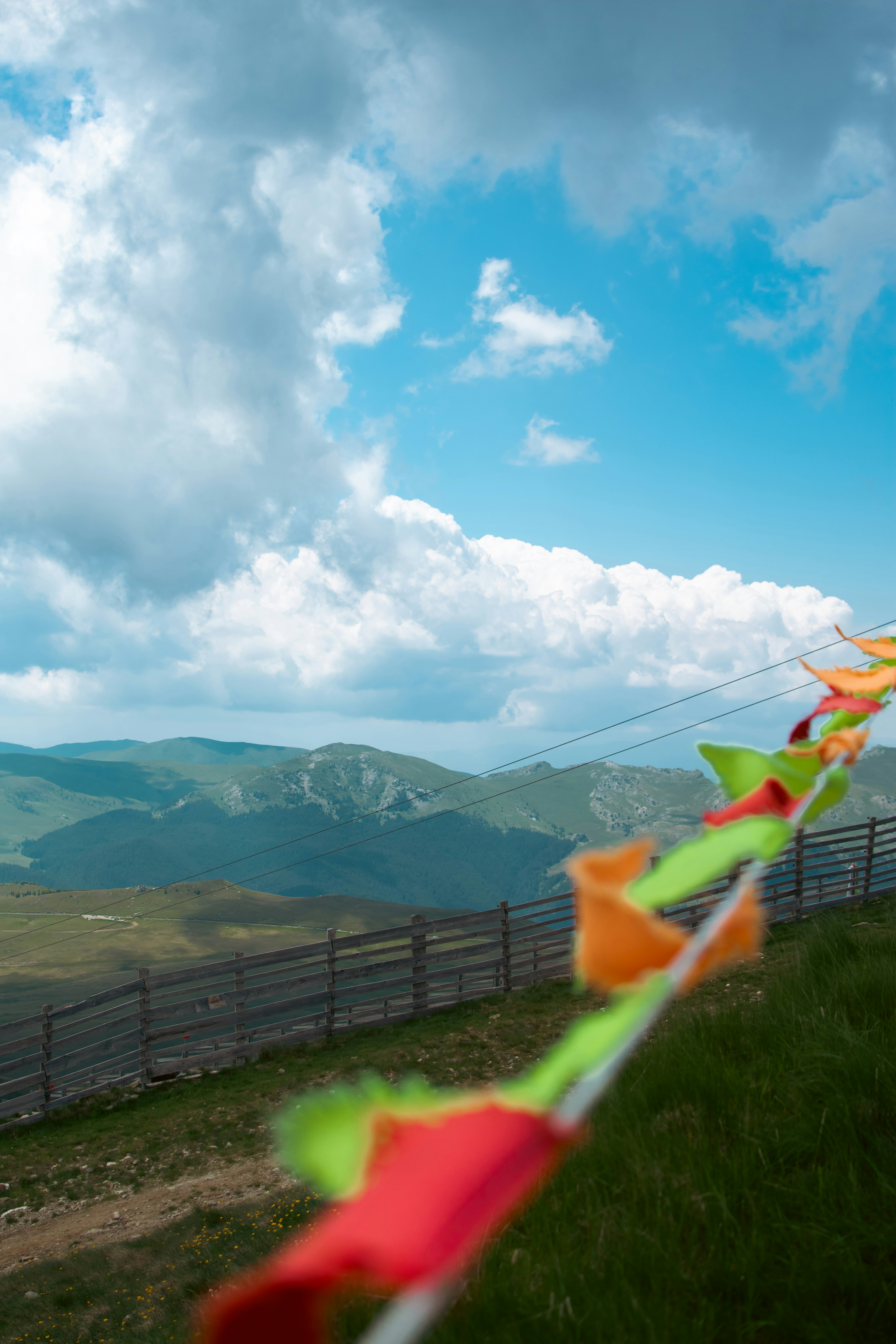 Fence and Flagged Ridge Under a Wide Sky
