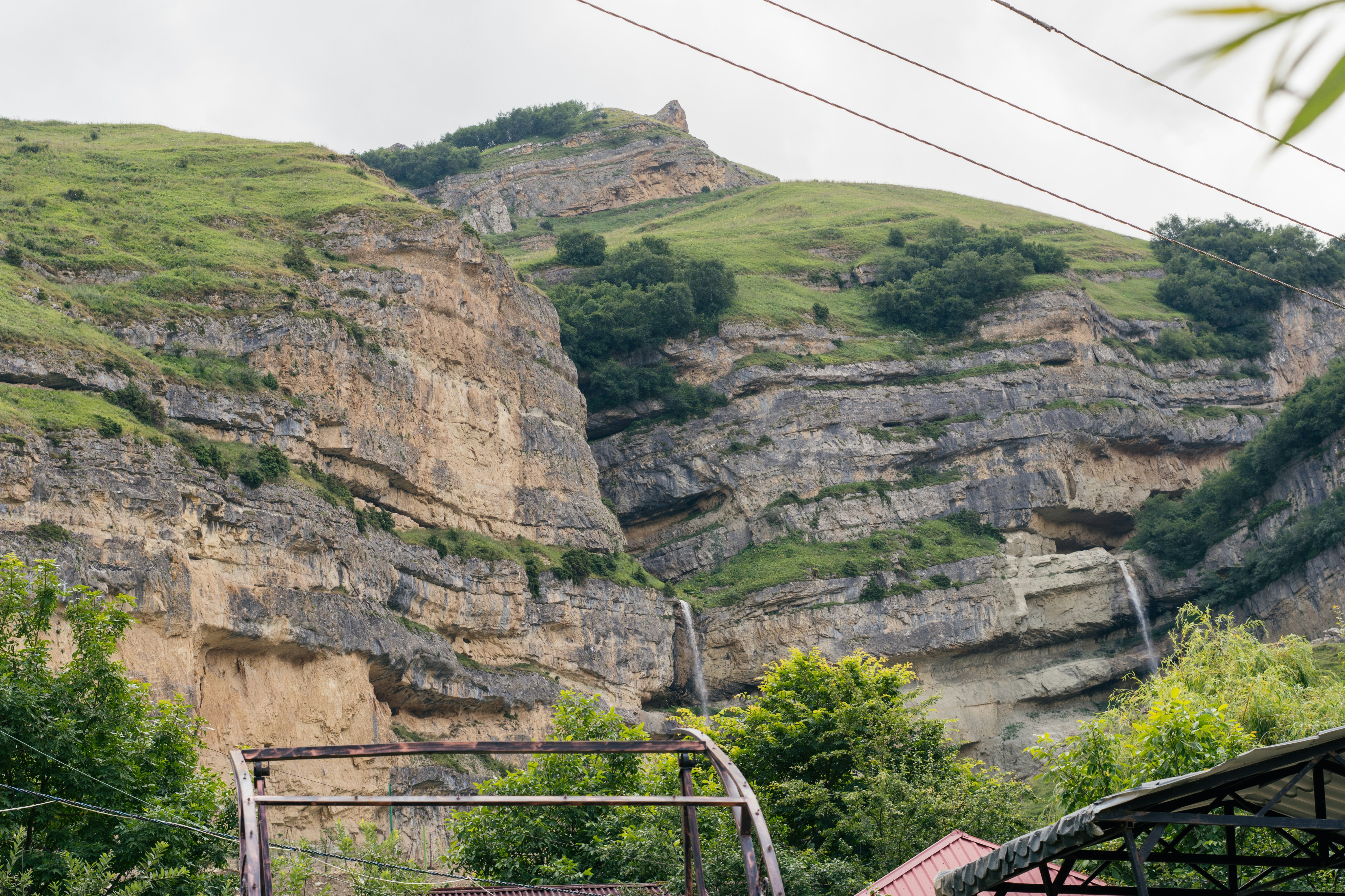 Rugged Karst Cliffs Framed by Green Terraces