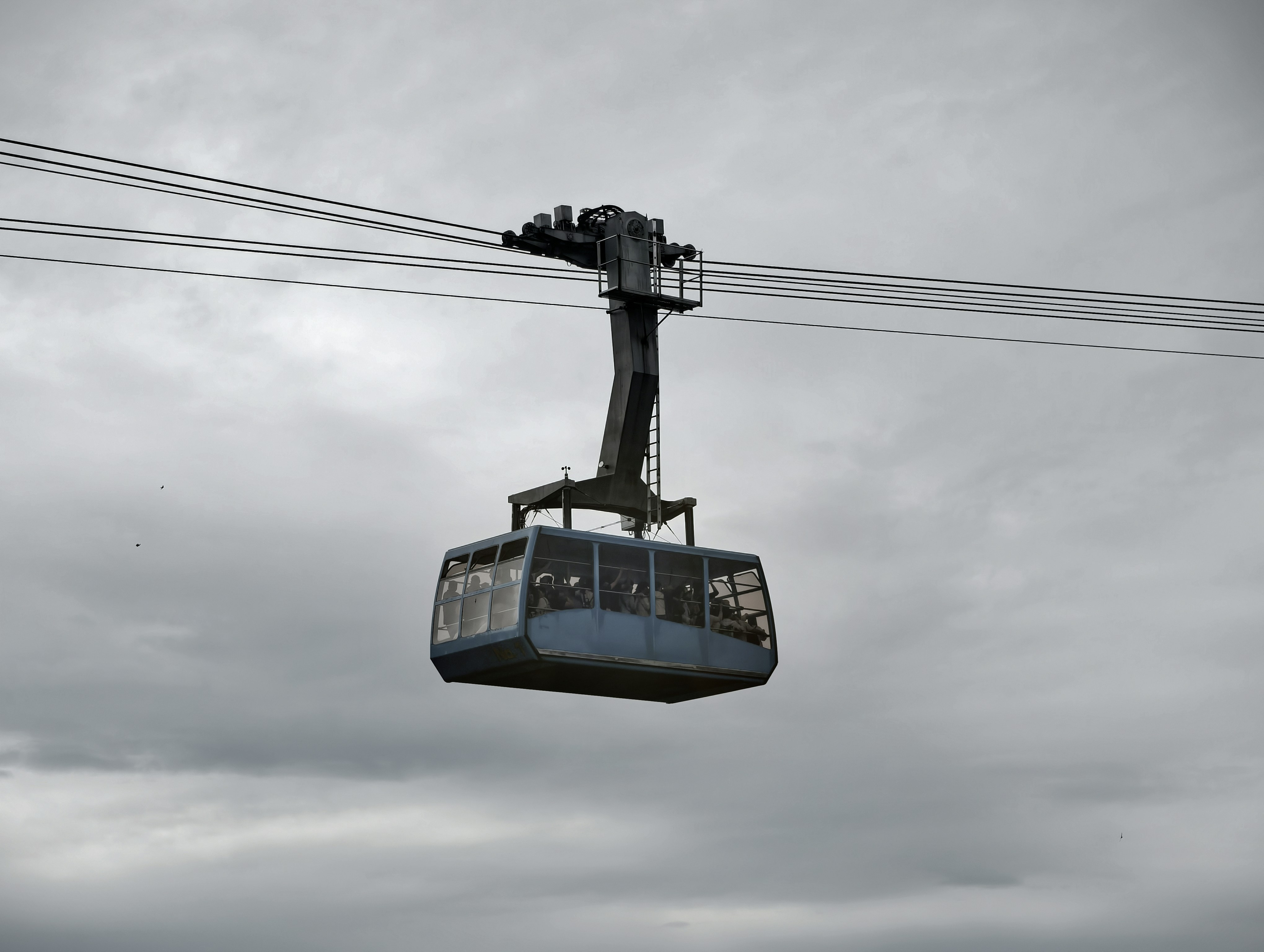 Midair Cable Car Duo Against a Bleak Sky