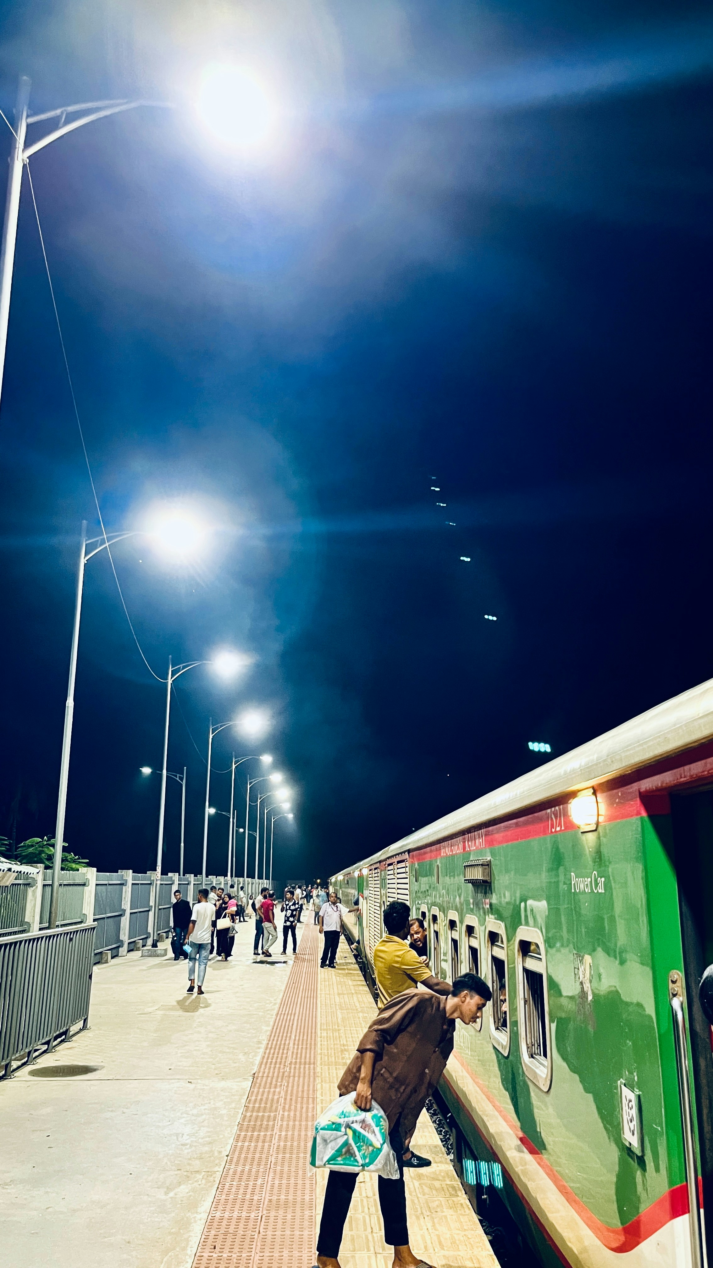Night on Platform: Train, Lights, and People in Motion