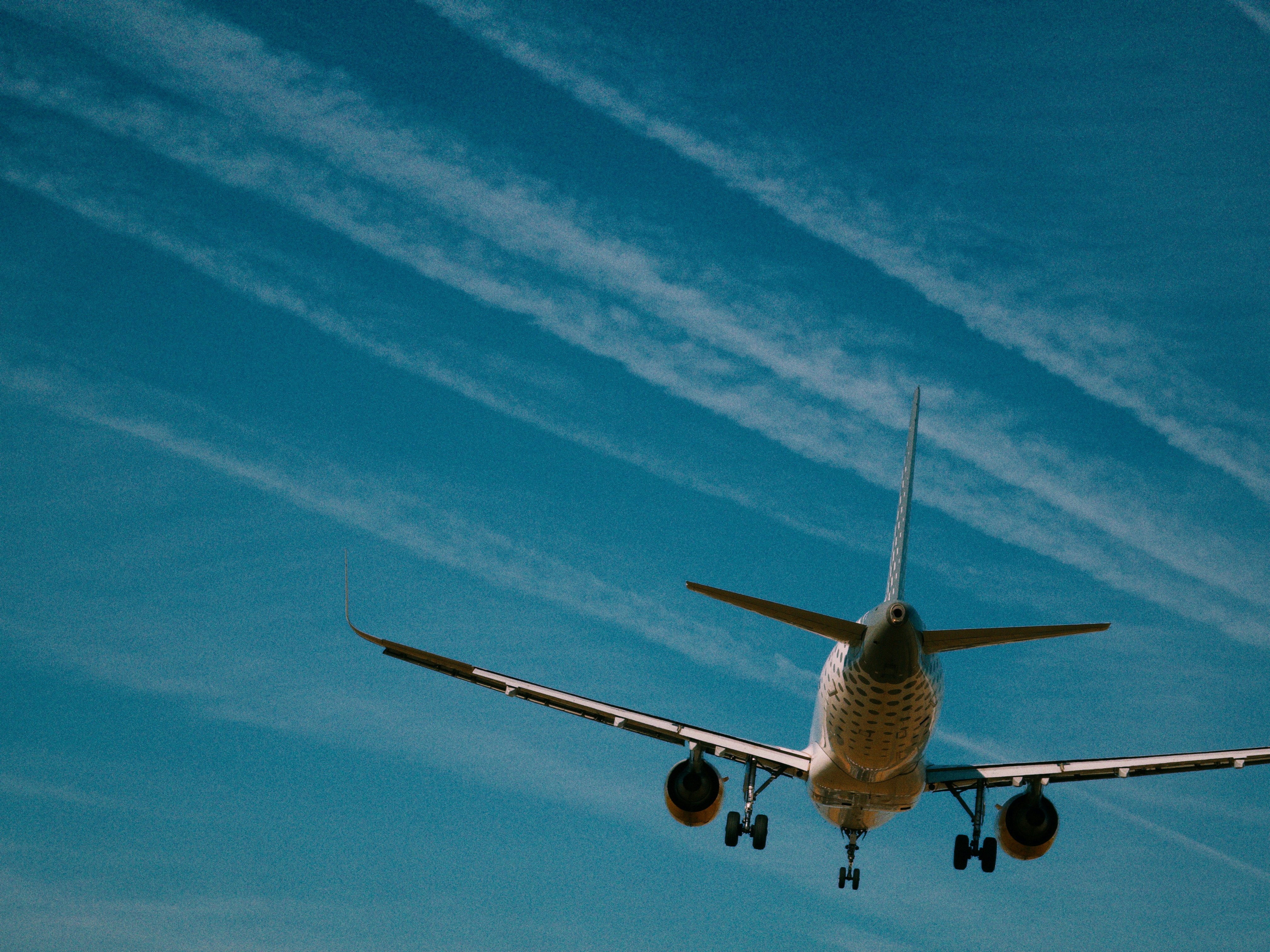 Approaching Wingbeat: A jetliner in ascent against a streaked sky