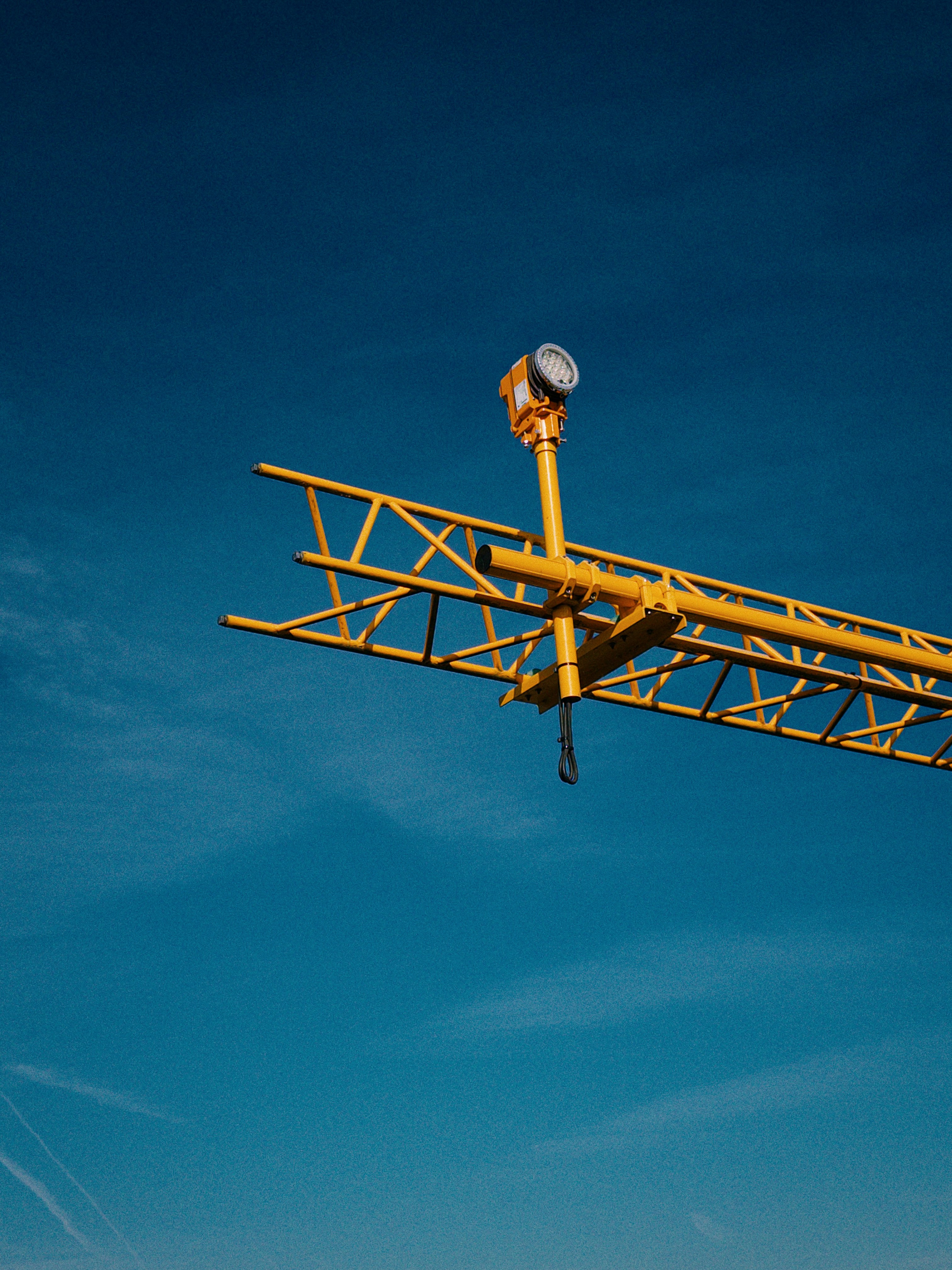 Golden Crane Arm Reaches into a Cerulean Sky