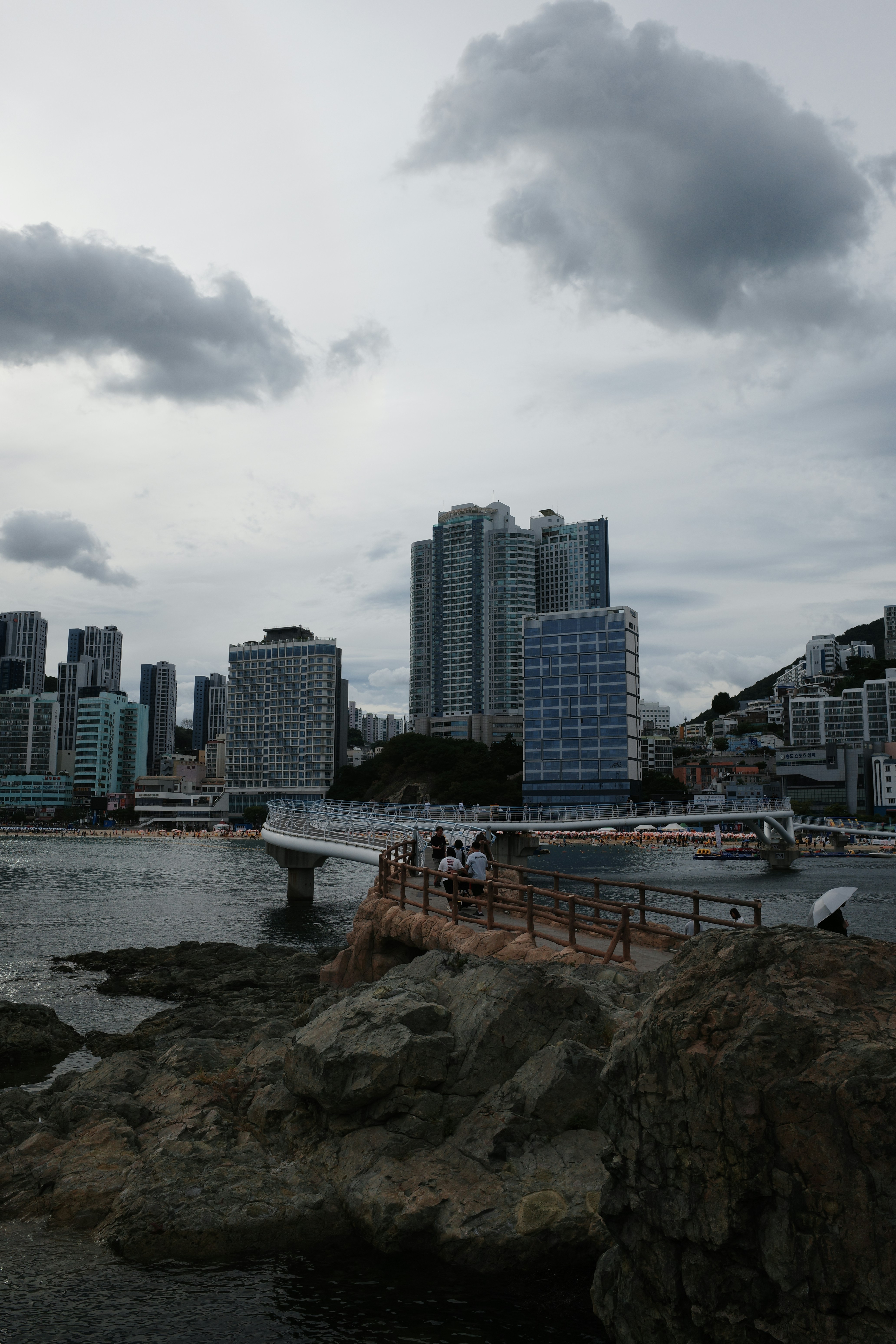 Harbor Promenade: Cityscape Over Rock and Bridge