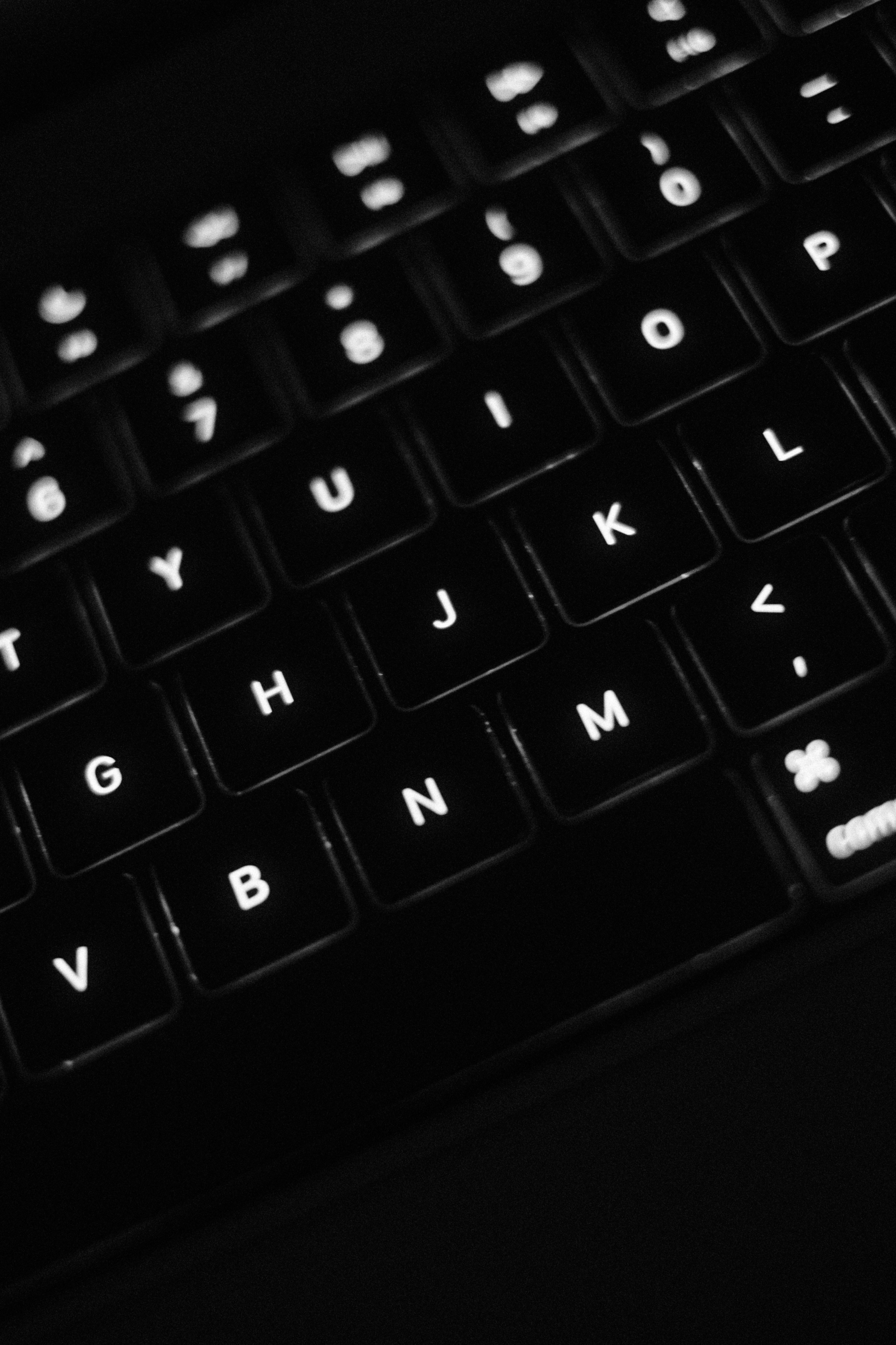 Midnight Keys: A Close-Up of Backlit Letters on a Keyboard