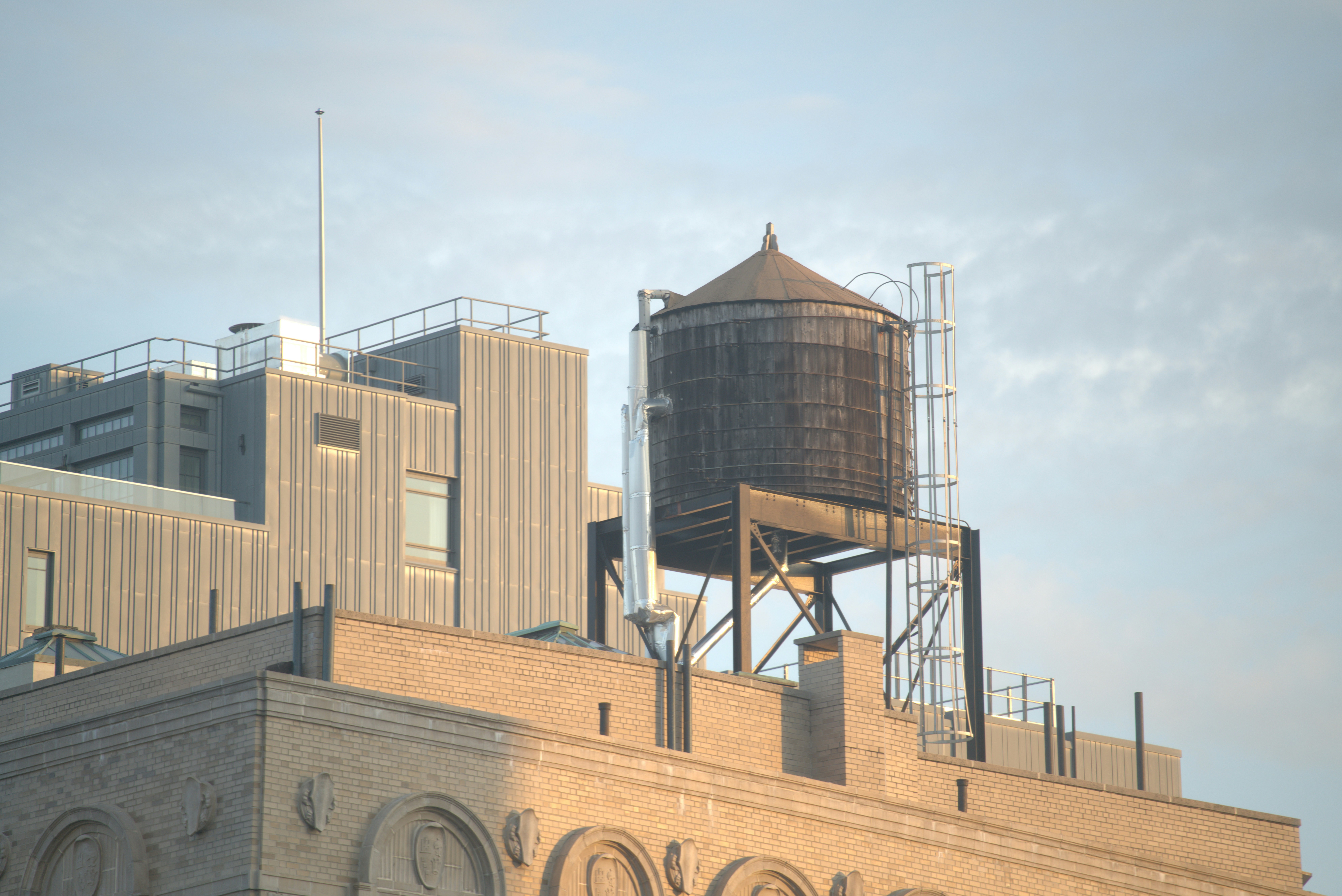 Industrial Rooftop Silhouette: Water Tower Above the City Edge