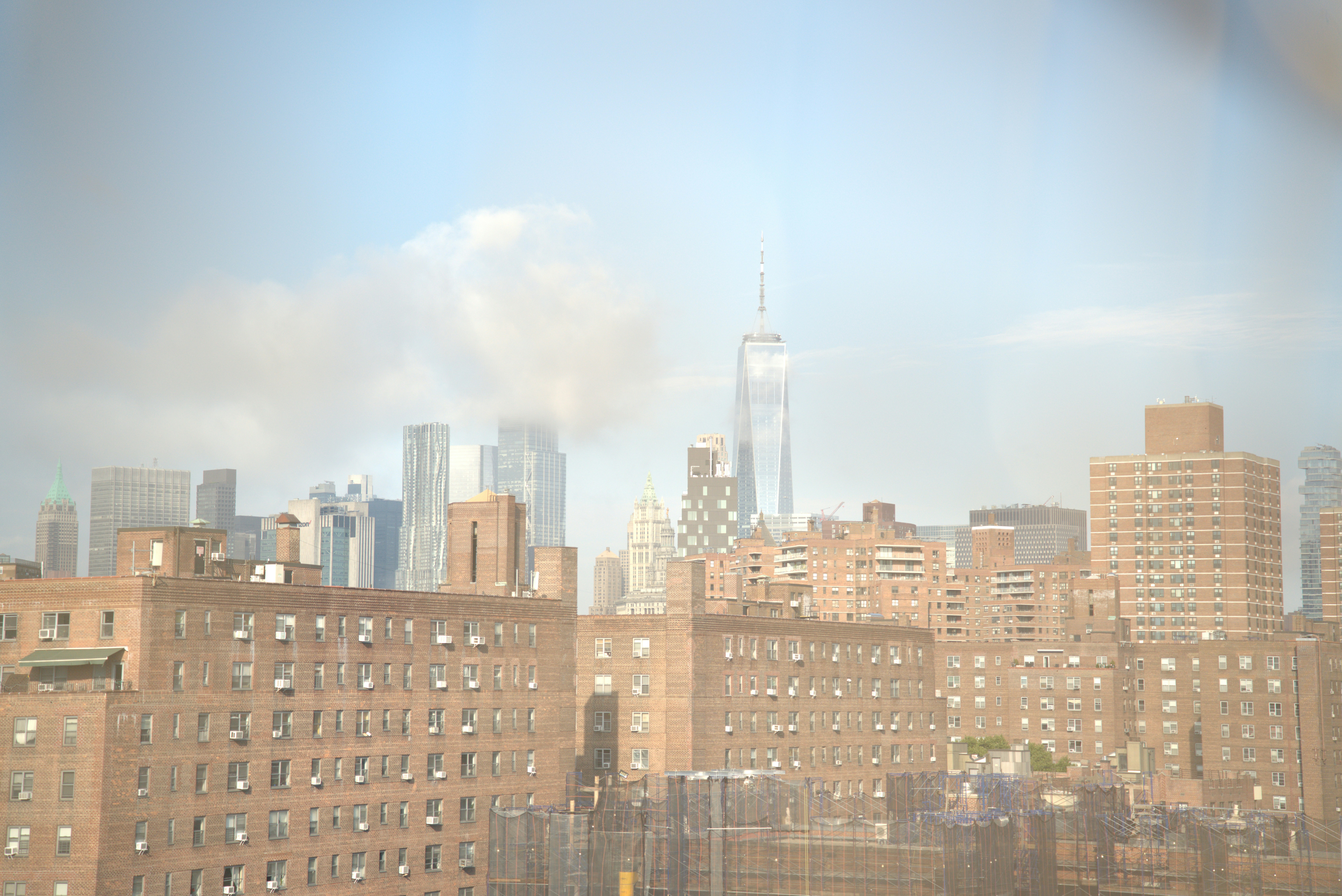 City in Soft Focus: Sunlit Brick Skyline with Subtle Glass Glow