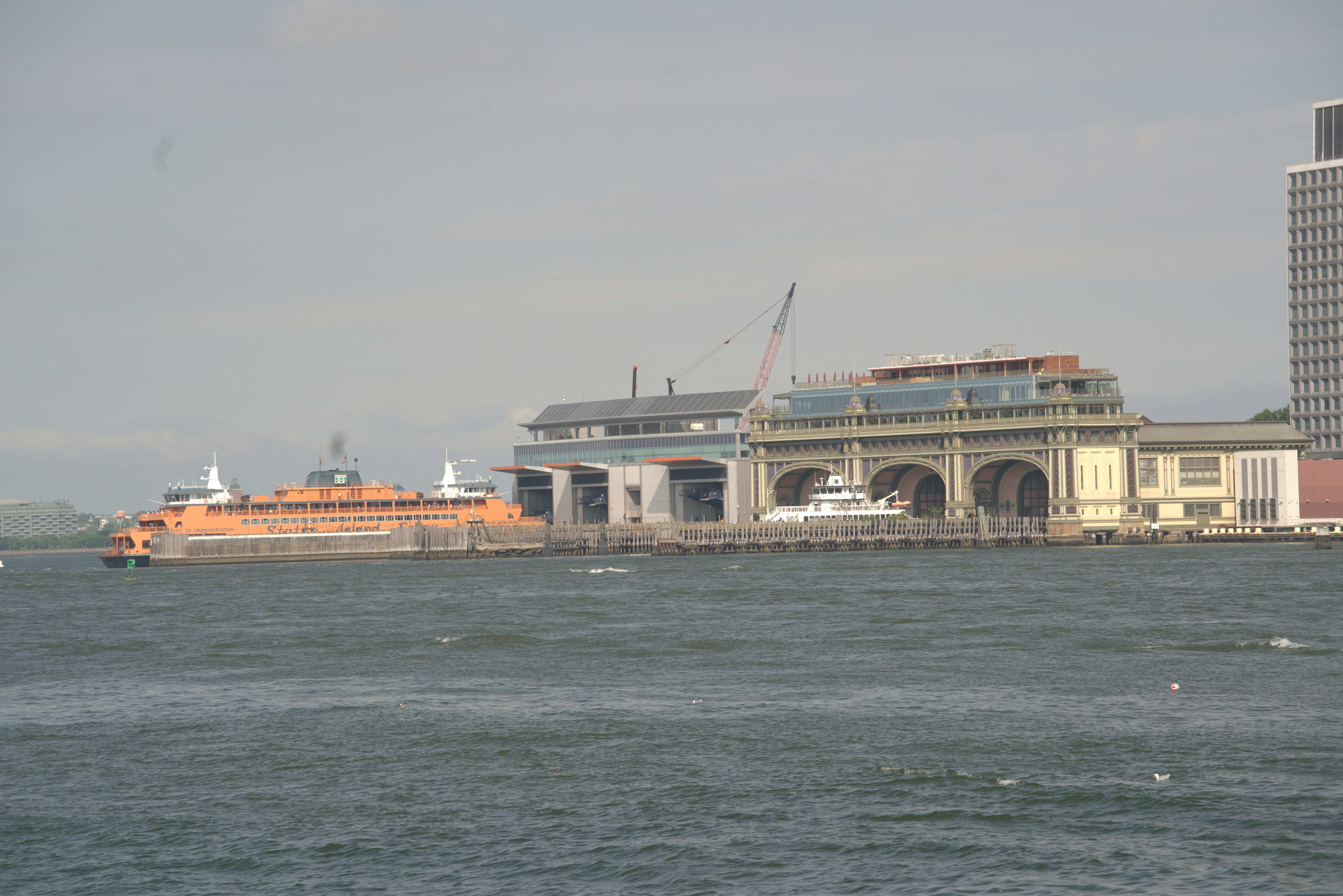 Orange Ferry at a Historic Pier: A Quiet Waterfront Moment