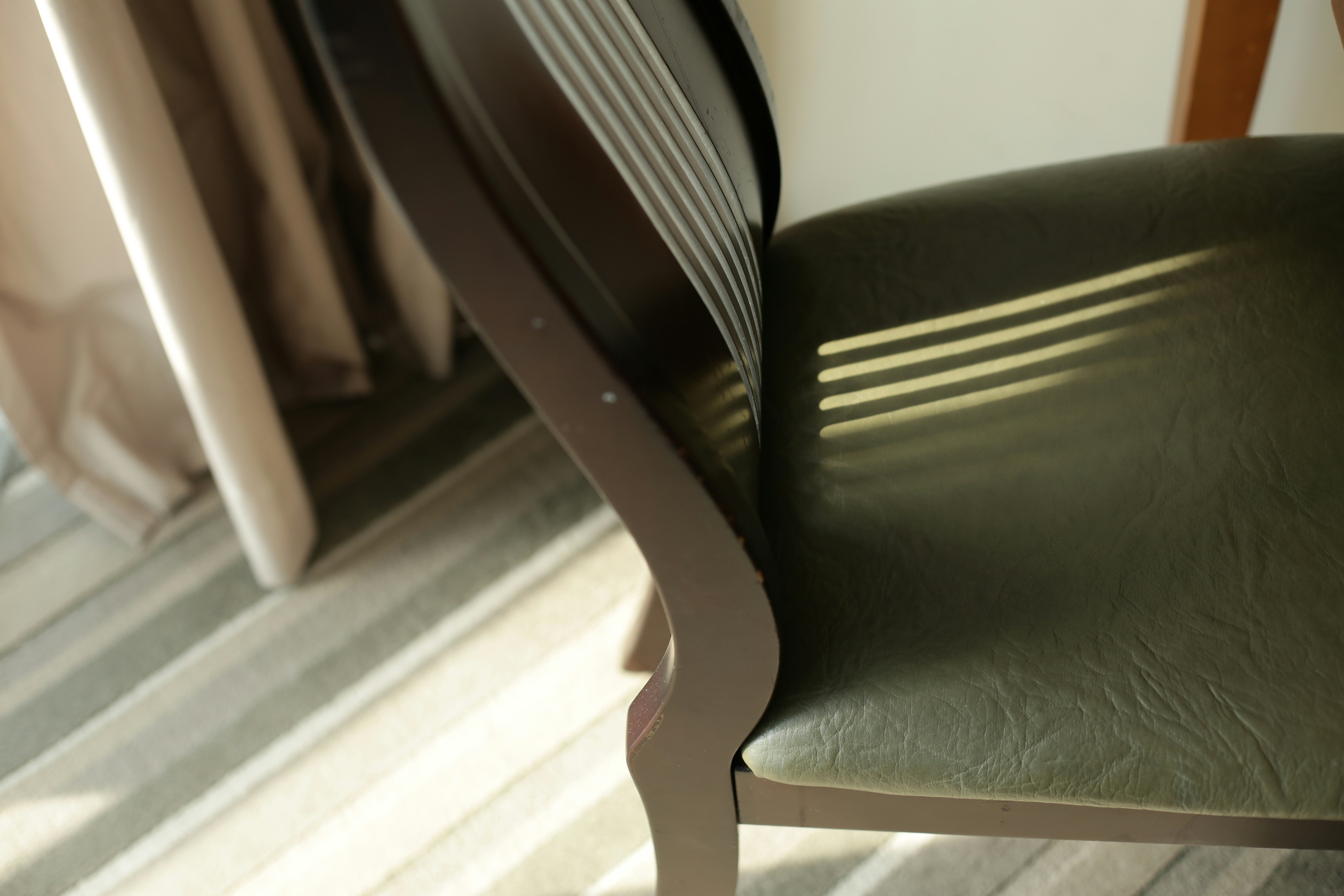 Folded Straps and Shadowed Chair: A Quiet Corner Portrait