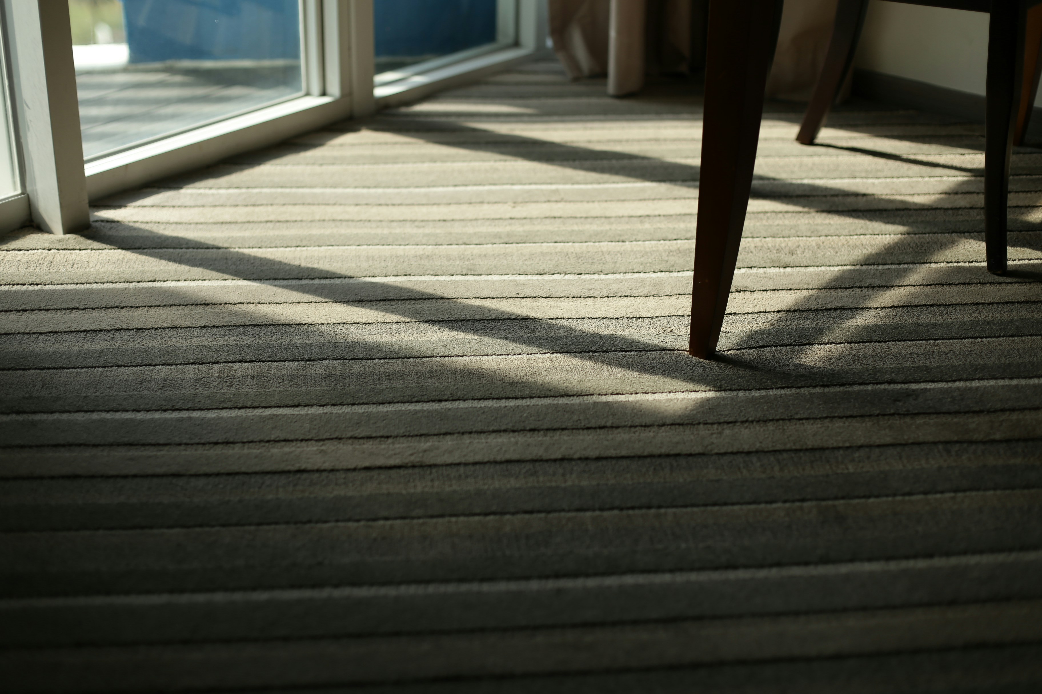 Sunlit Stripes: Quiet Geometry of a Carpet and Chairs