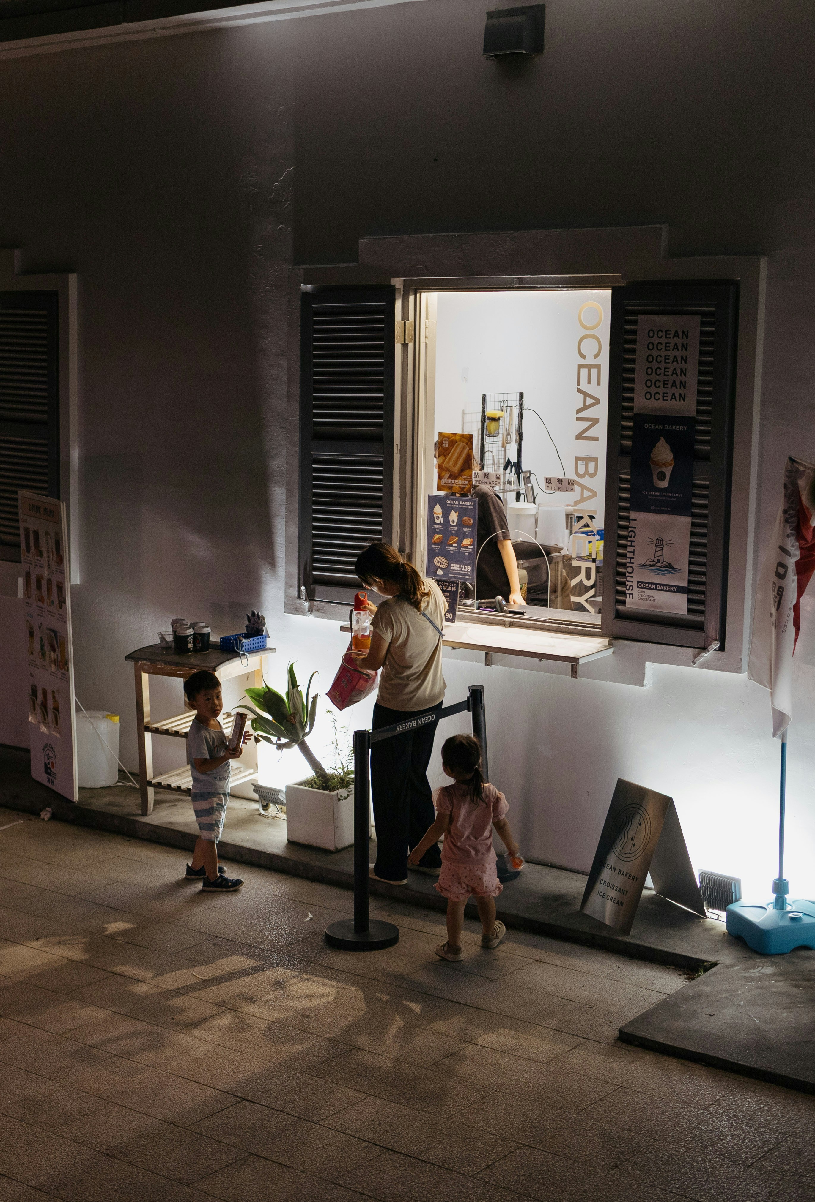 Night at the Window: A Family Moment by the Ocean Bar