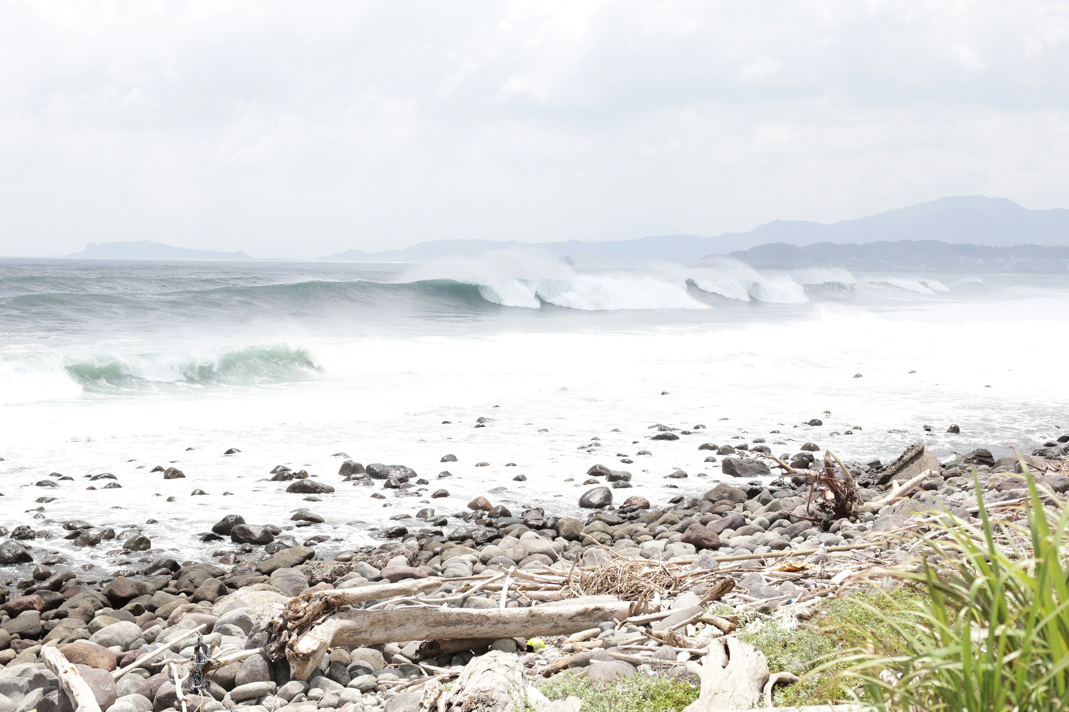 Soft surf and Pebble Shoreline under Misty Horizon