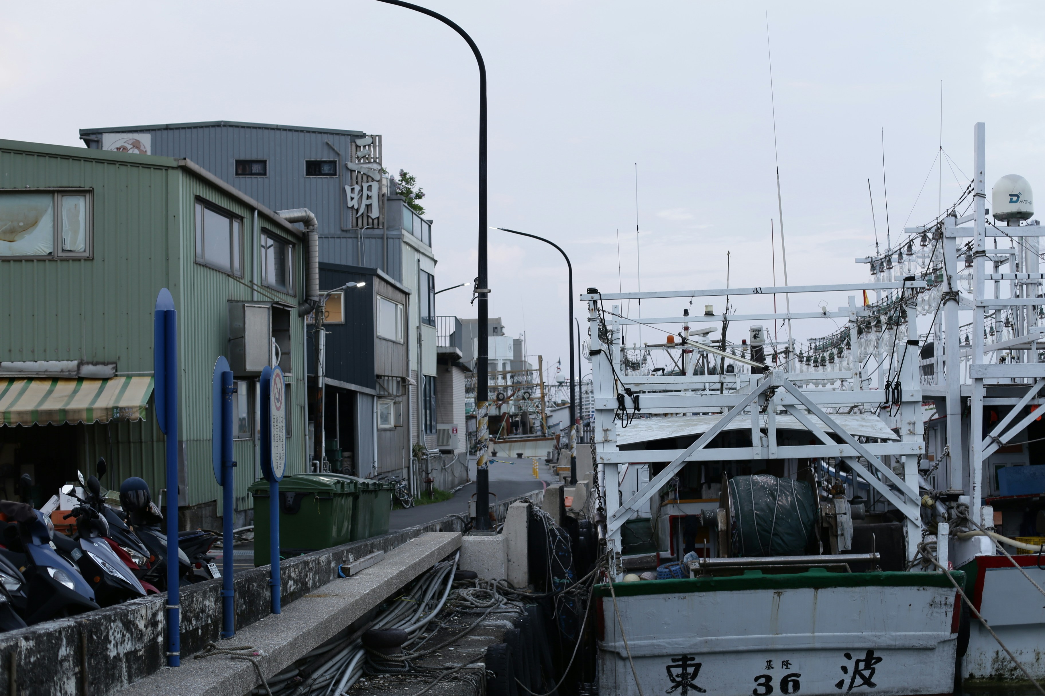 Harbor and Docks: Boats and Warehouses Framed by a Riverside Street