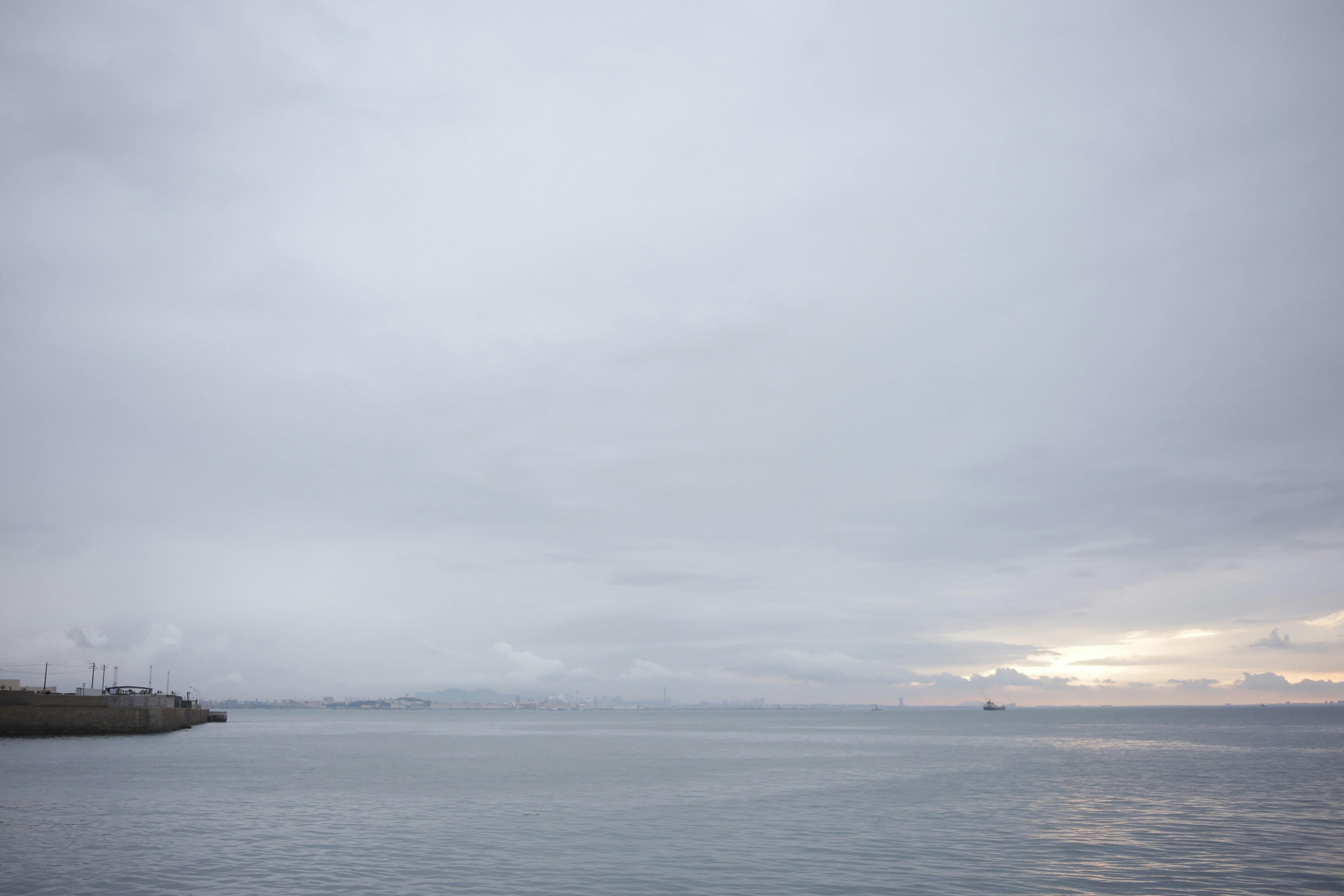 Quiet Horizon: Distant Ships at Dusk Over a Calm Sea