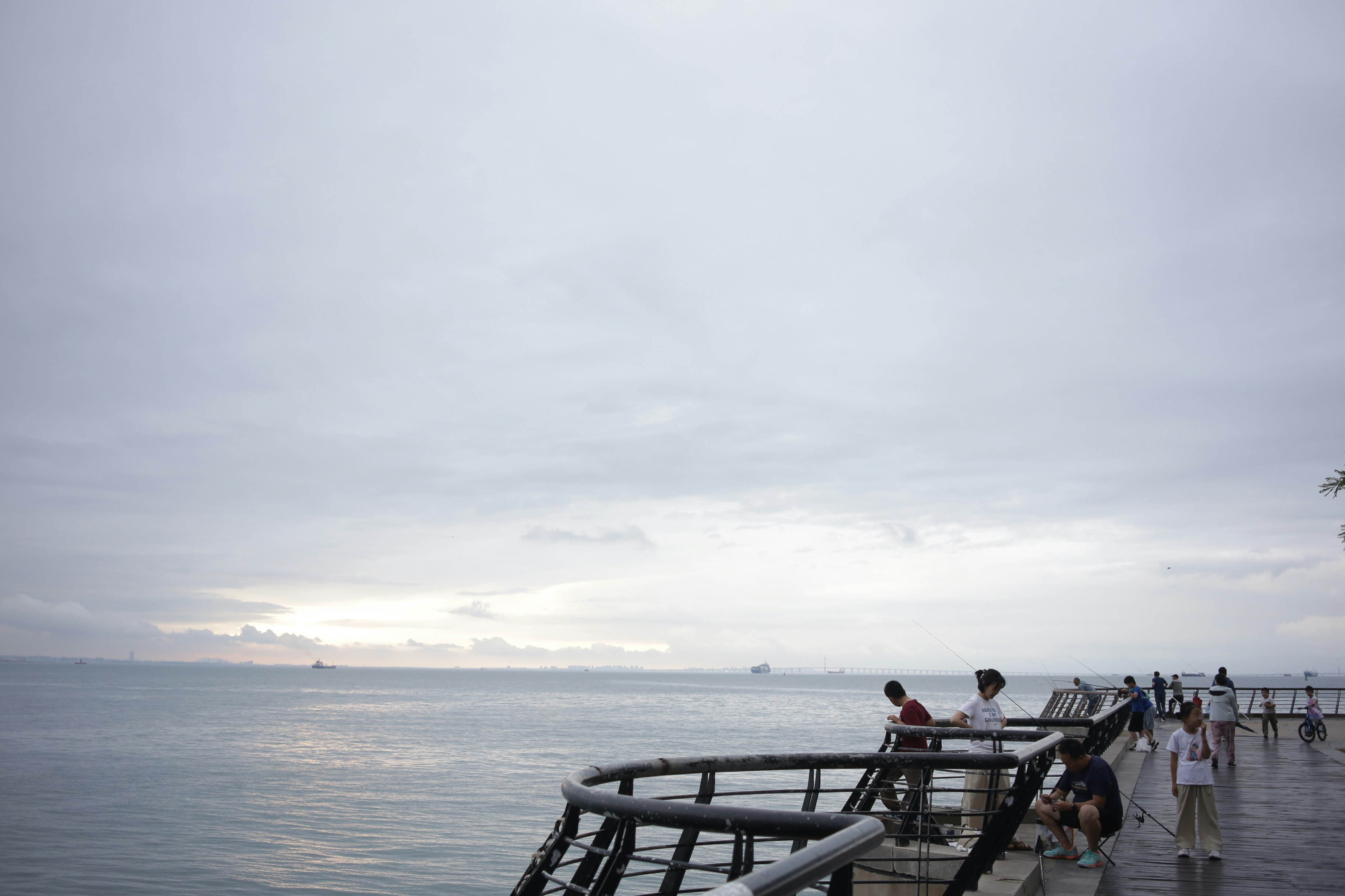 Pier of Quiet Figures: Sunset, Sea, and Stroll