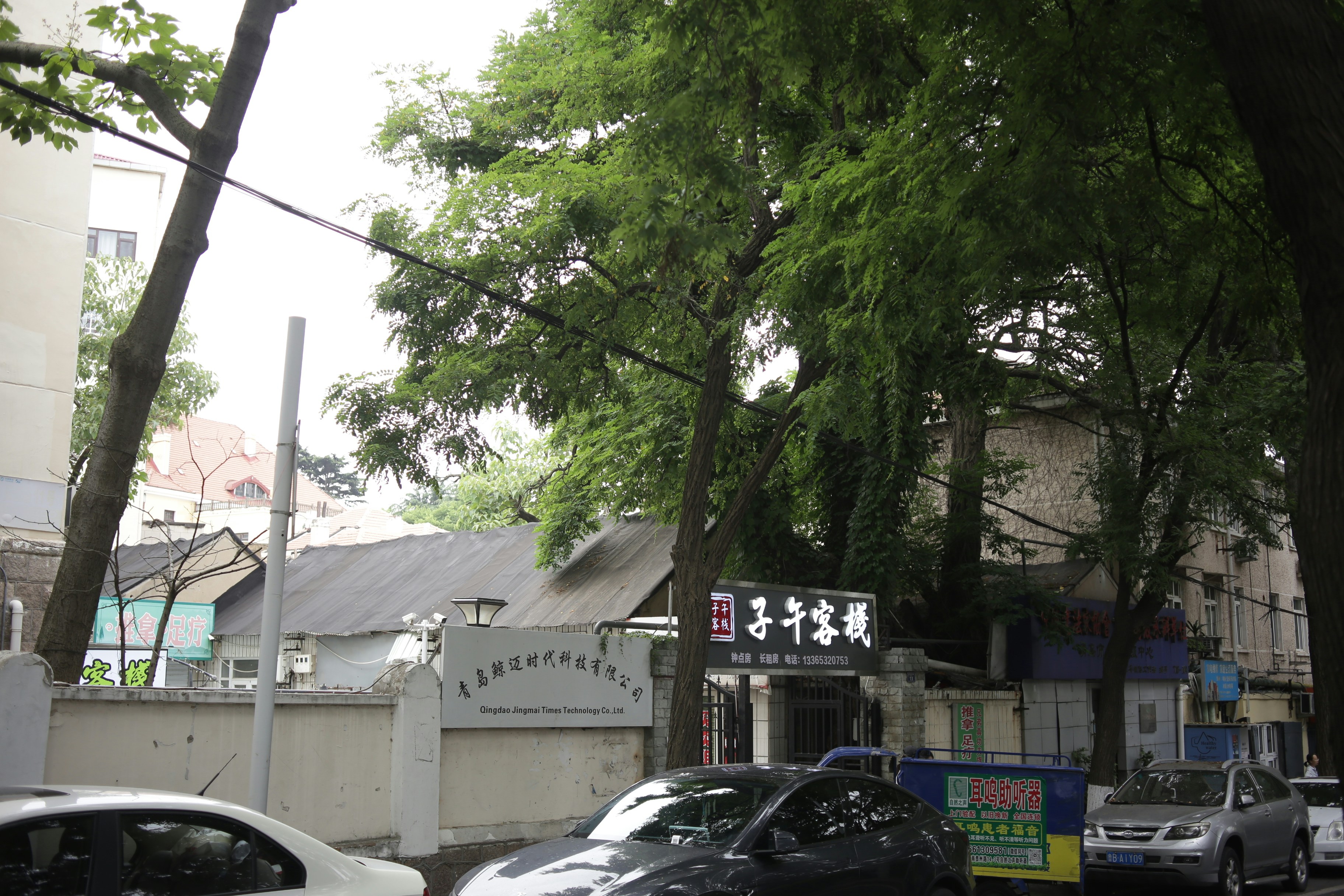 Urban Street Facade: Car Lines and Shaded Archway