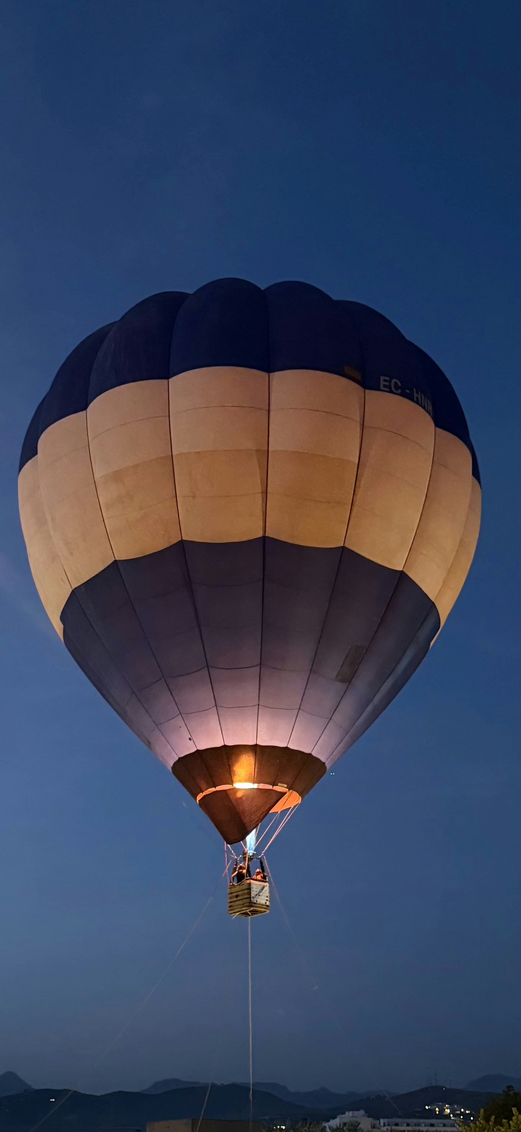 Ascending Lantern: A Balloon Lift Against Twilight