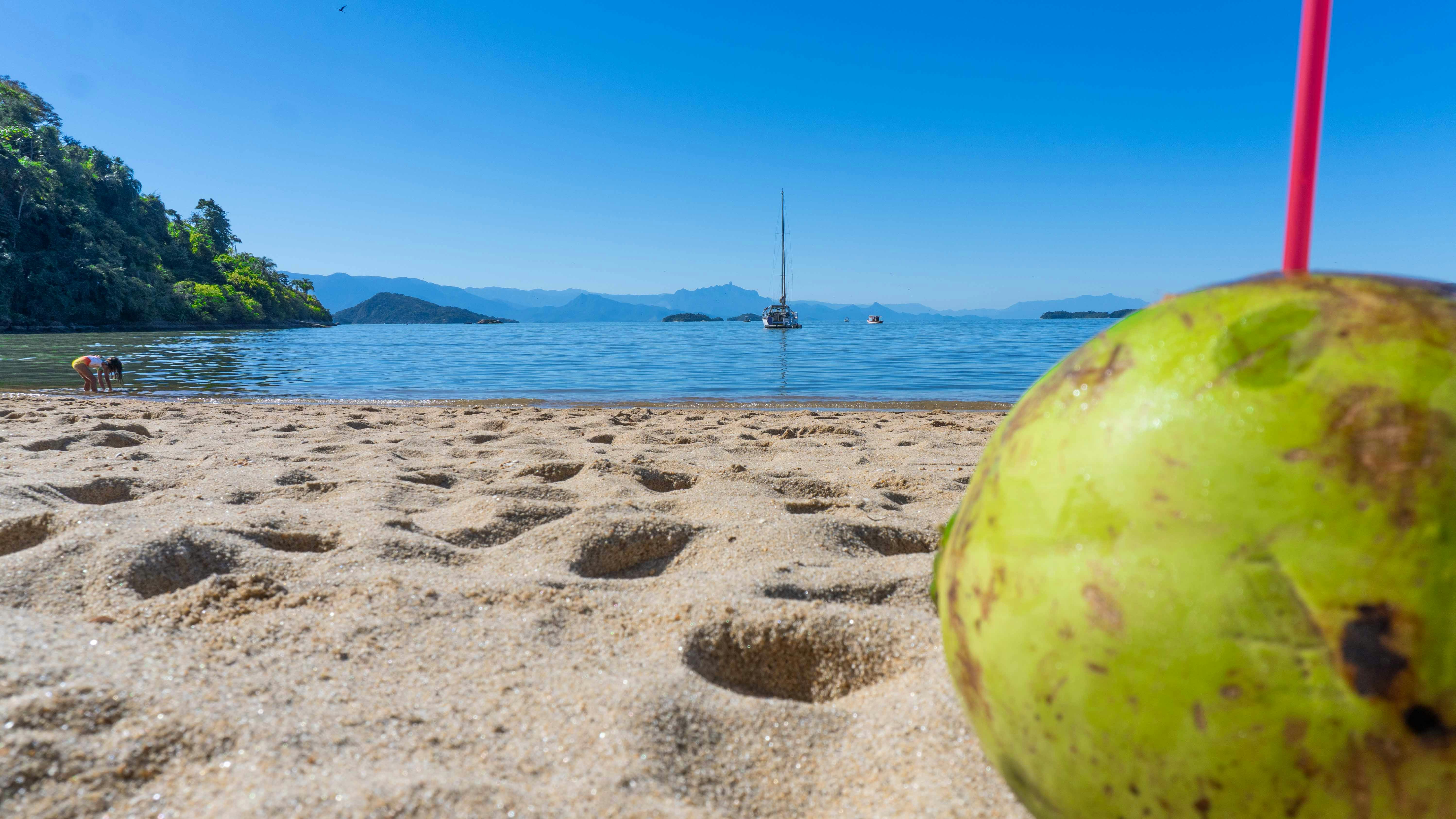 Coconut Corner: Sunny Beach with Distant Yachts