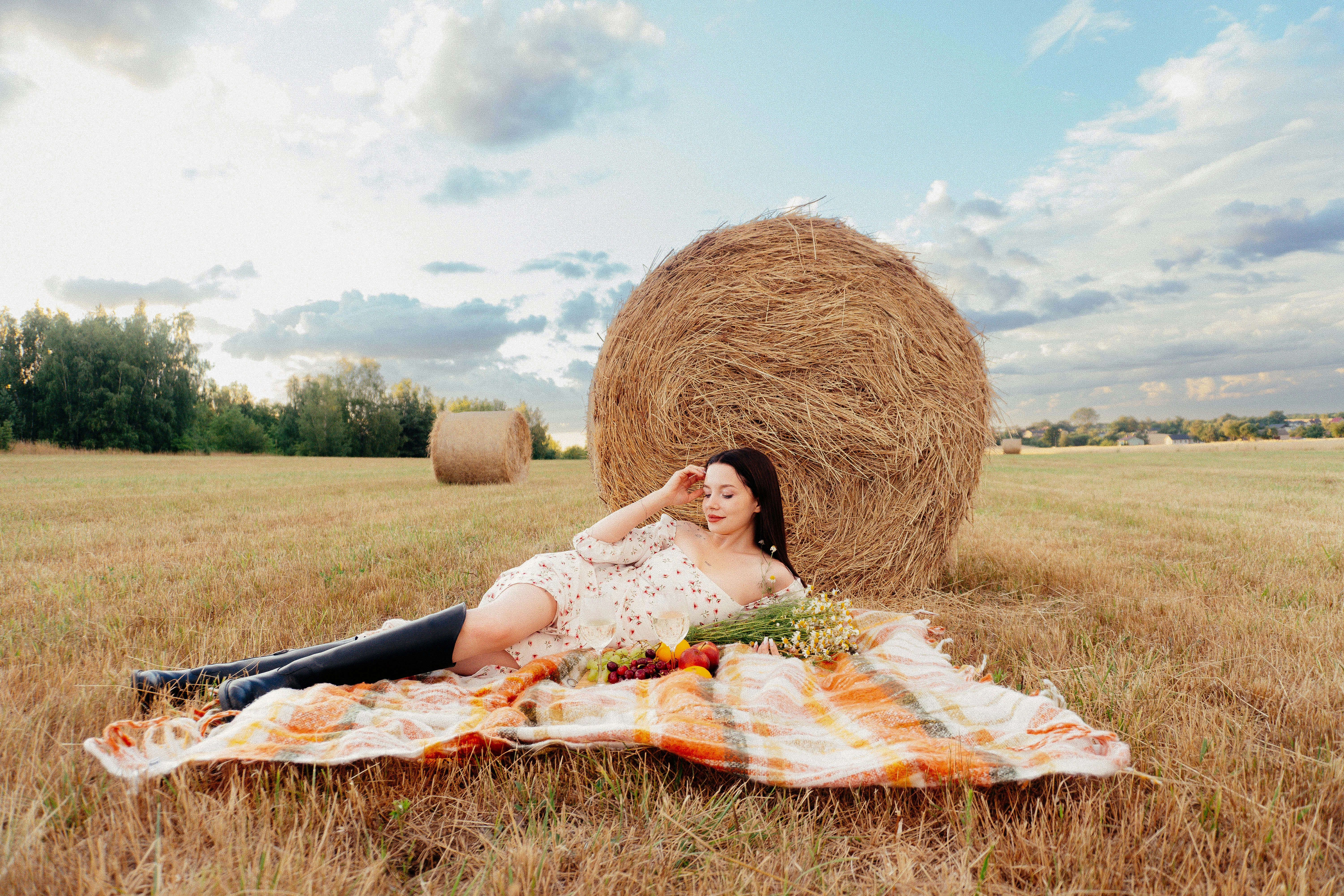 Relaxed Field Portrait Beneath a Hay Bale
